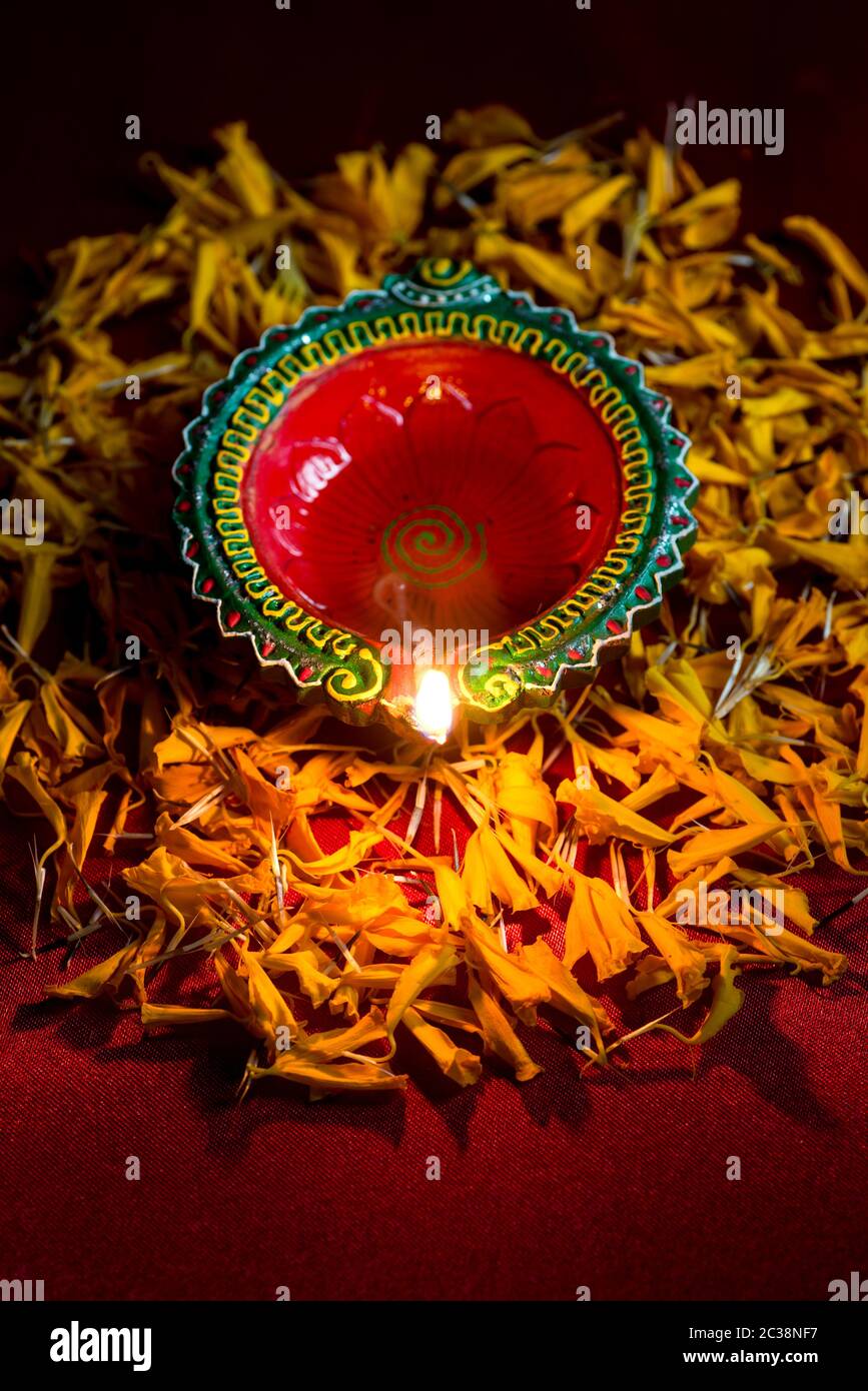Happy Diwali - Clay Diya lamps lit during Diwali celebration. Greetings ...