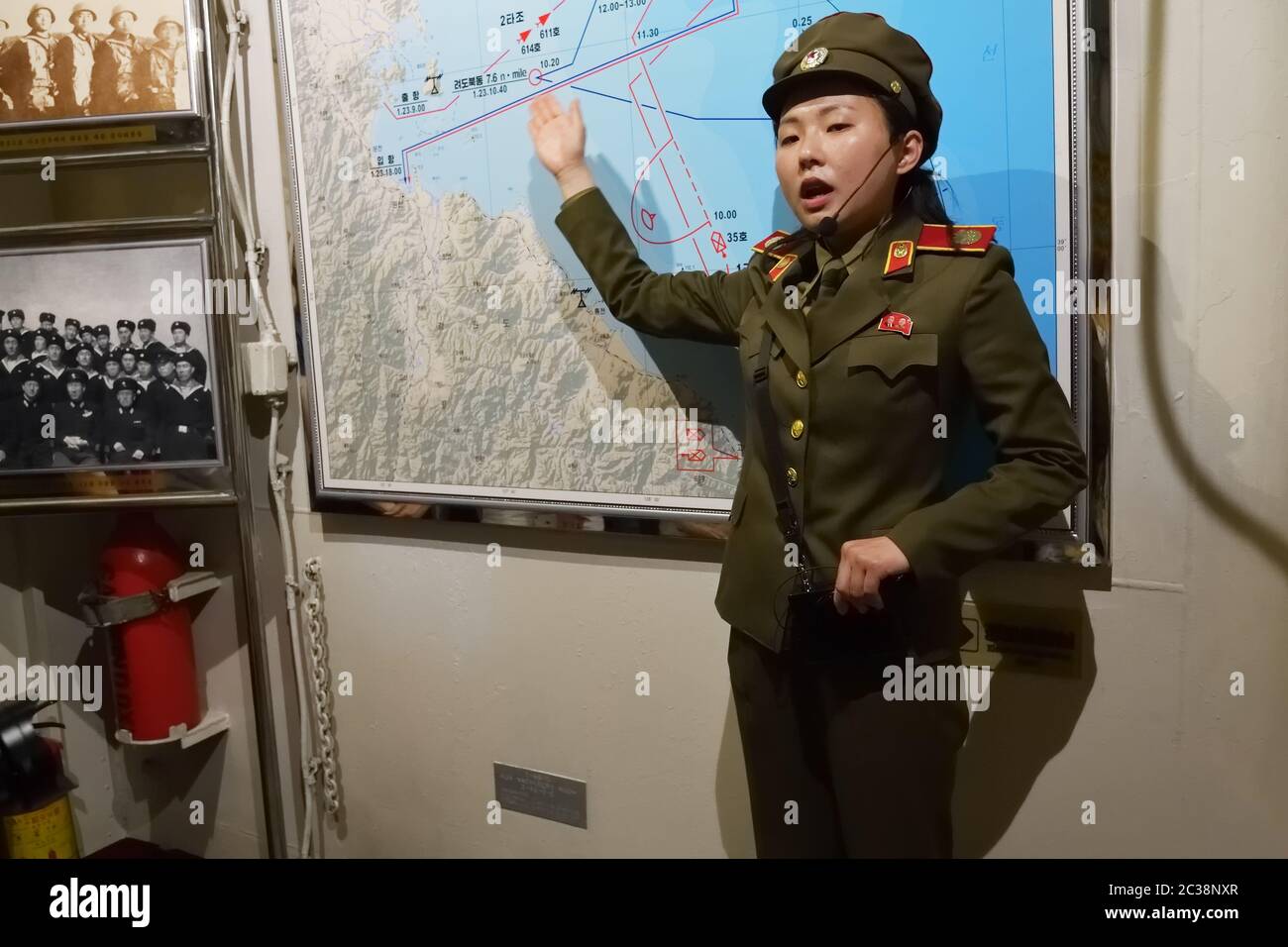 Pyongyang, North Korea - May 2, 2019: Guide in uniform gives tourists ...