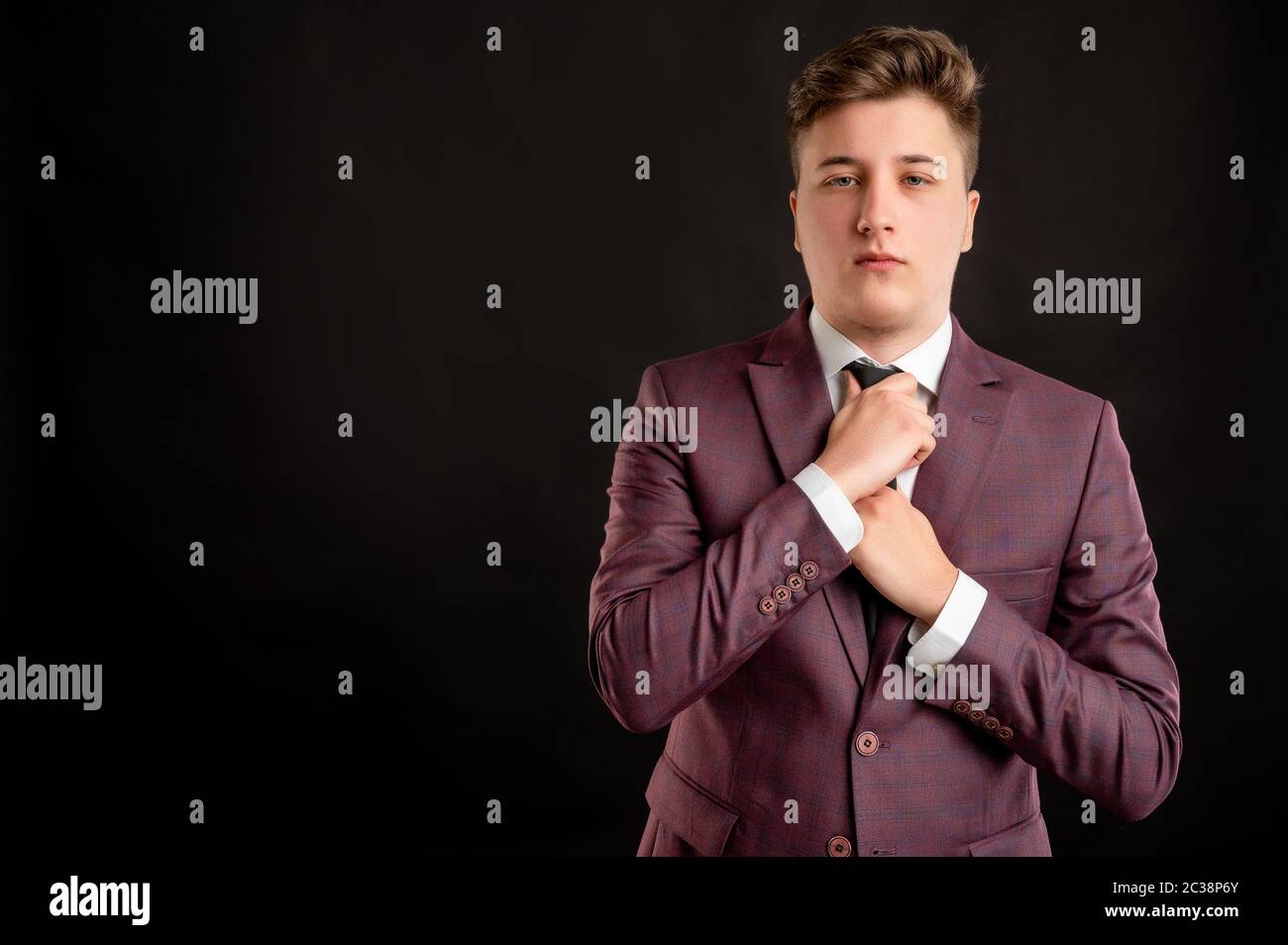 Law student with blond hair dressed in burgundy jacket, white shirt and ...