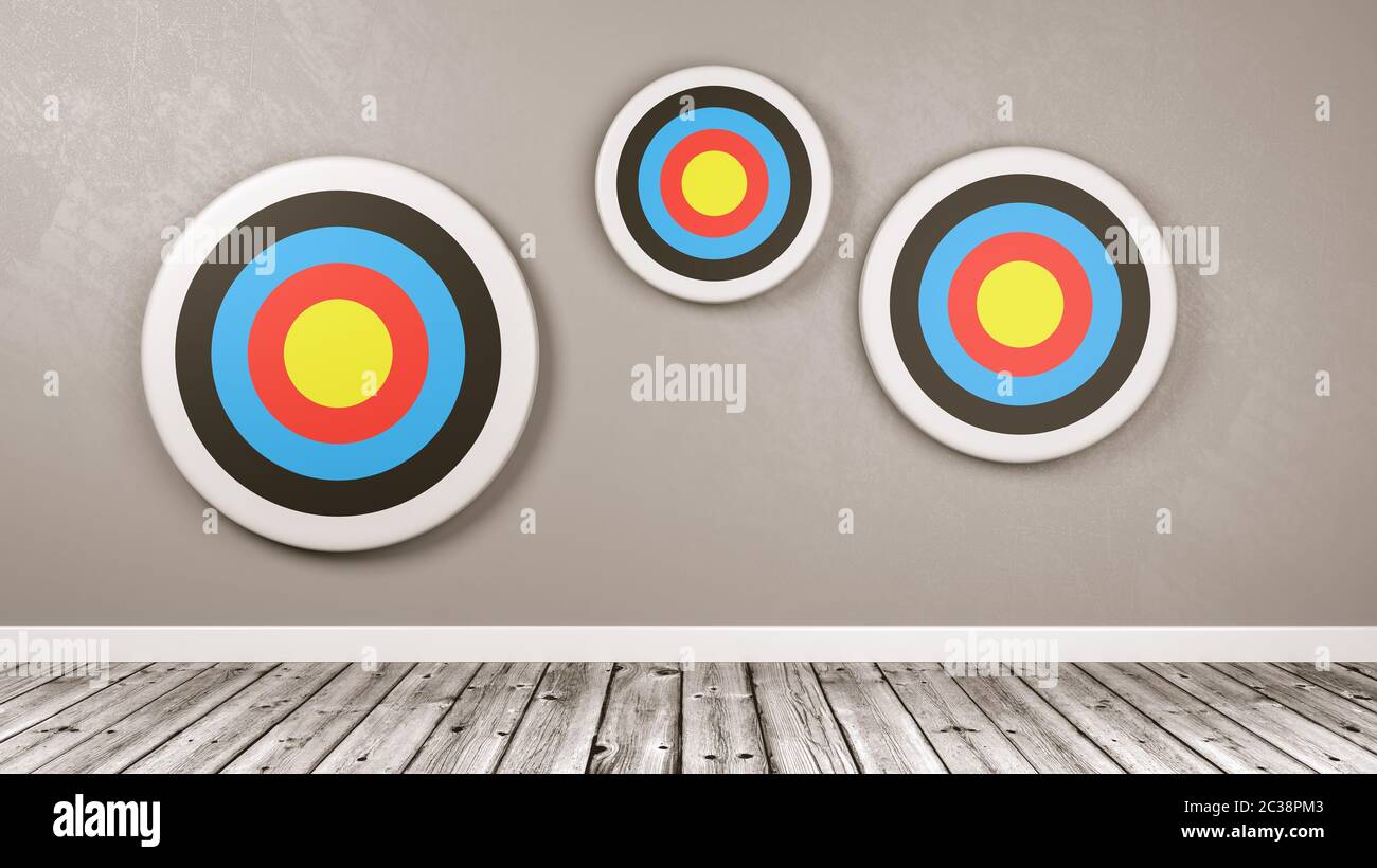 Three Different Size Colorful Arrow Targets Against a Gray Wall with ...