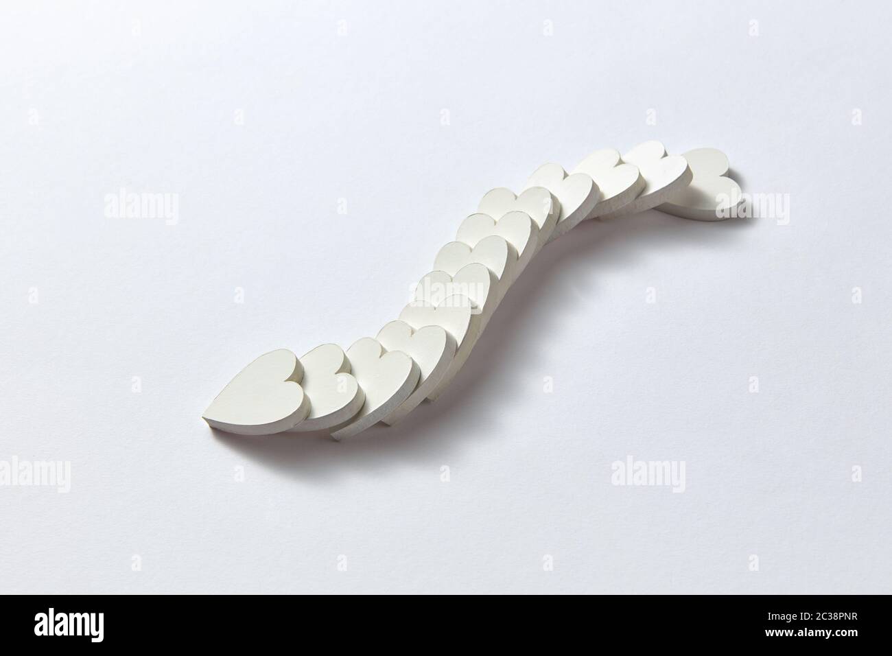 Curve chain from plaster hearts in the shape of snake Stock Photo - Alamy