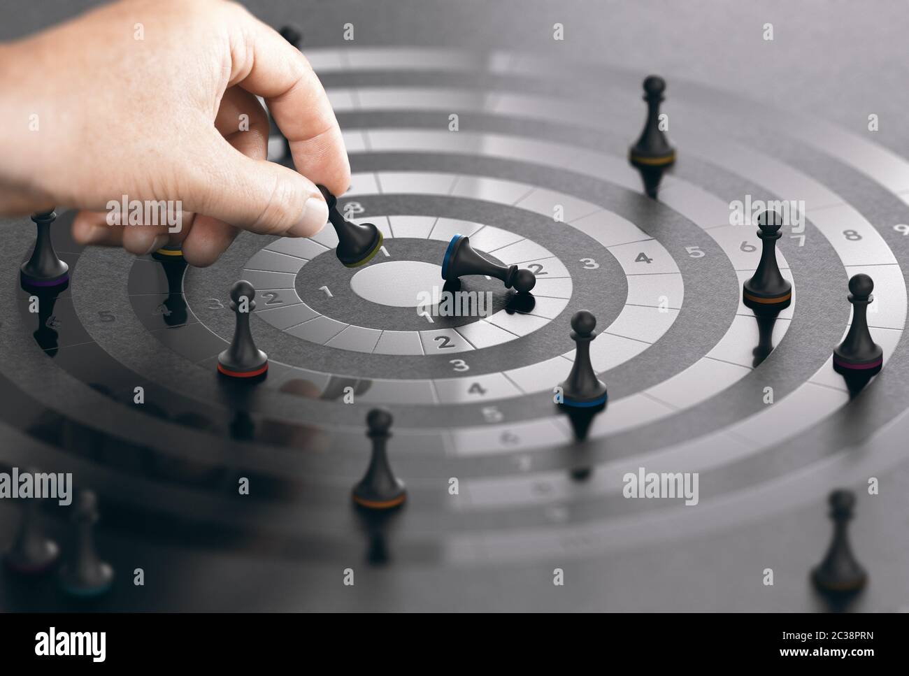 Hand moving pawn on a conceptual target to win the first place ...