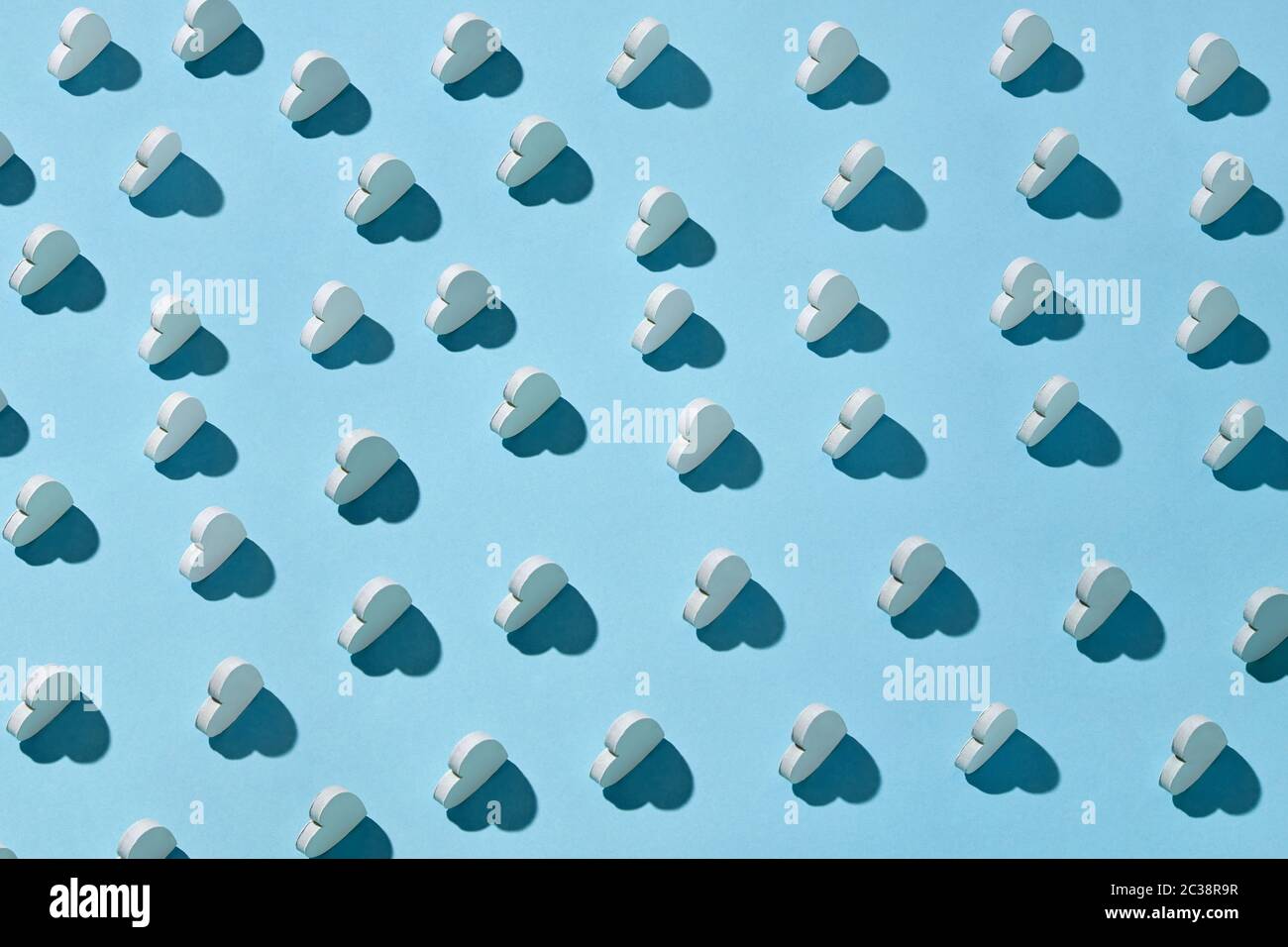 Celebratory pattern from small hearts with hard shadows Stock Photo - Alamy