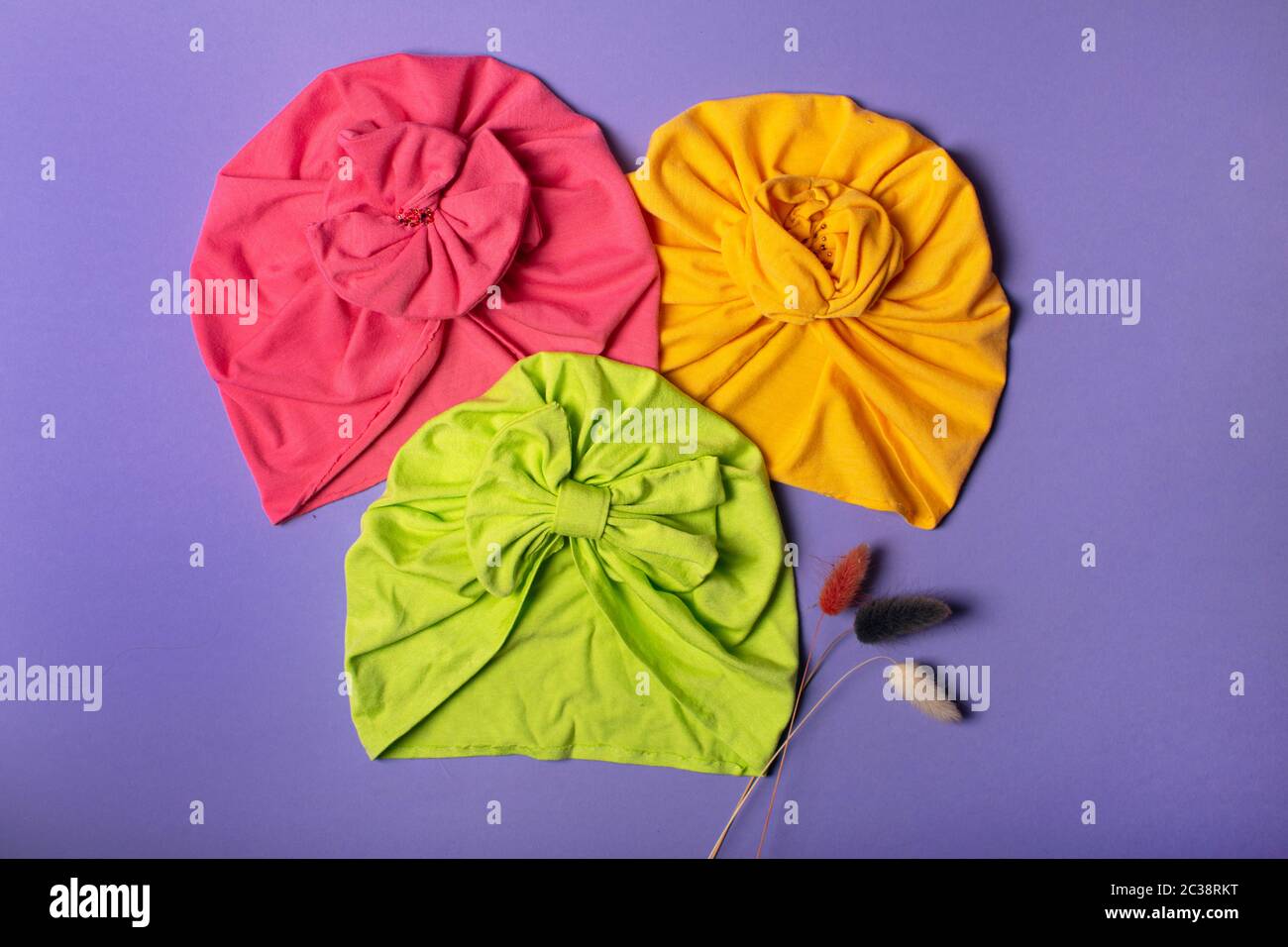 Three cute children headband or turban on lilac background Stock Photo ...