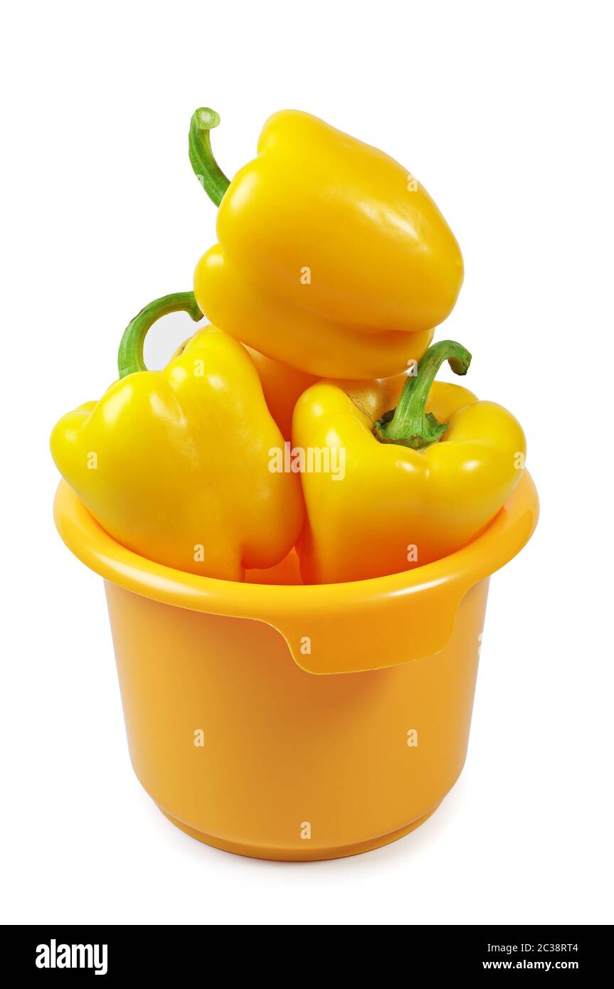 Yellow paprika in bowl on white background Stock Photo - Alamy