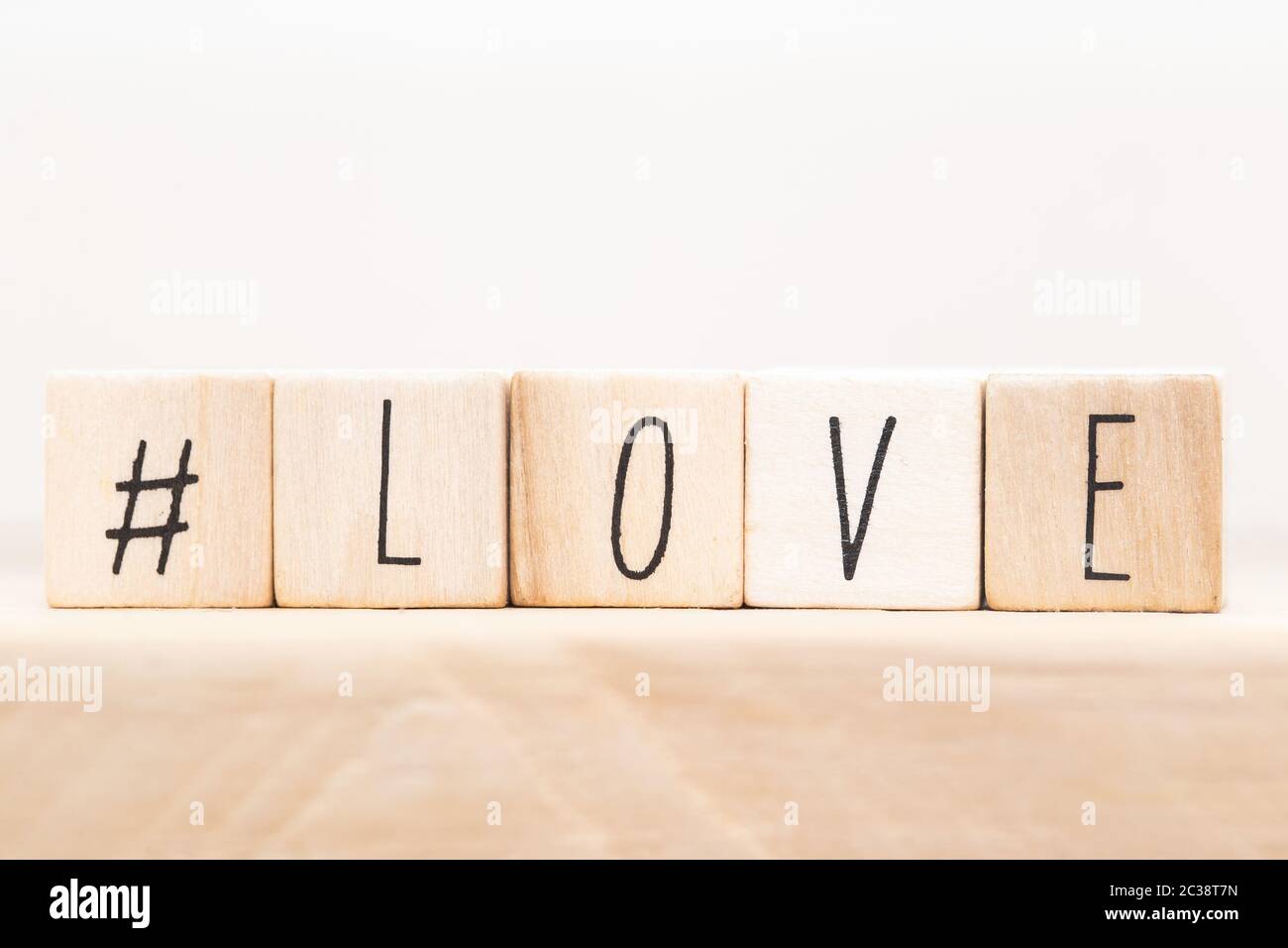 Word Love on wooden cubes with Hashtag, close-up near white background ...