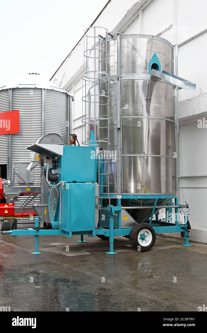 Mobile style cereal dryer at trailer in front of farm Stock Photo - Alamy