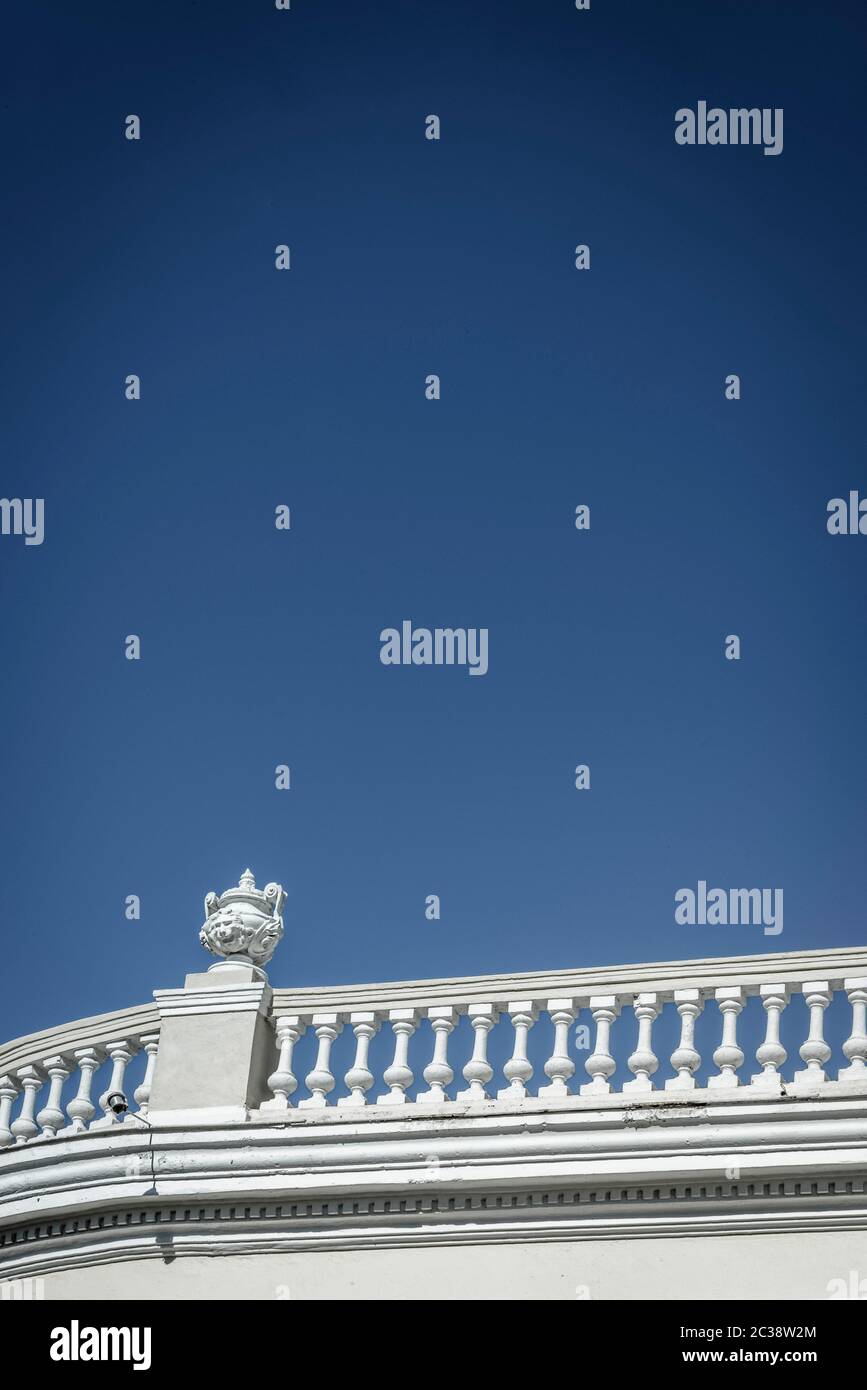 White classical balustrade on top of a roof and big blue sky, Merida ...