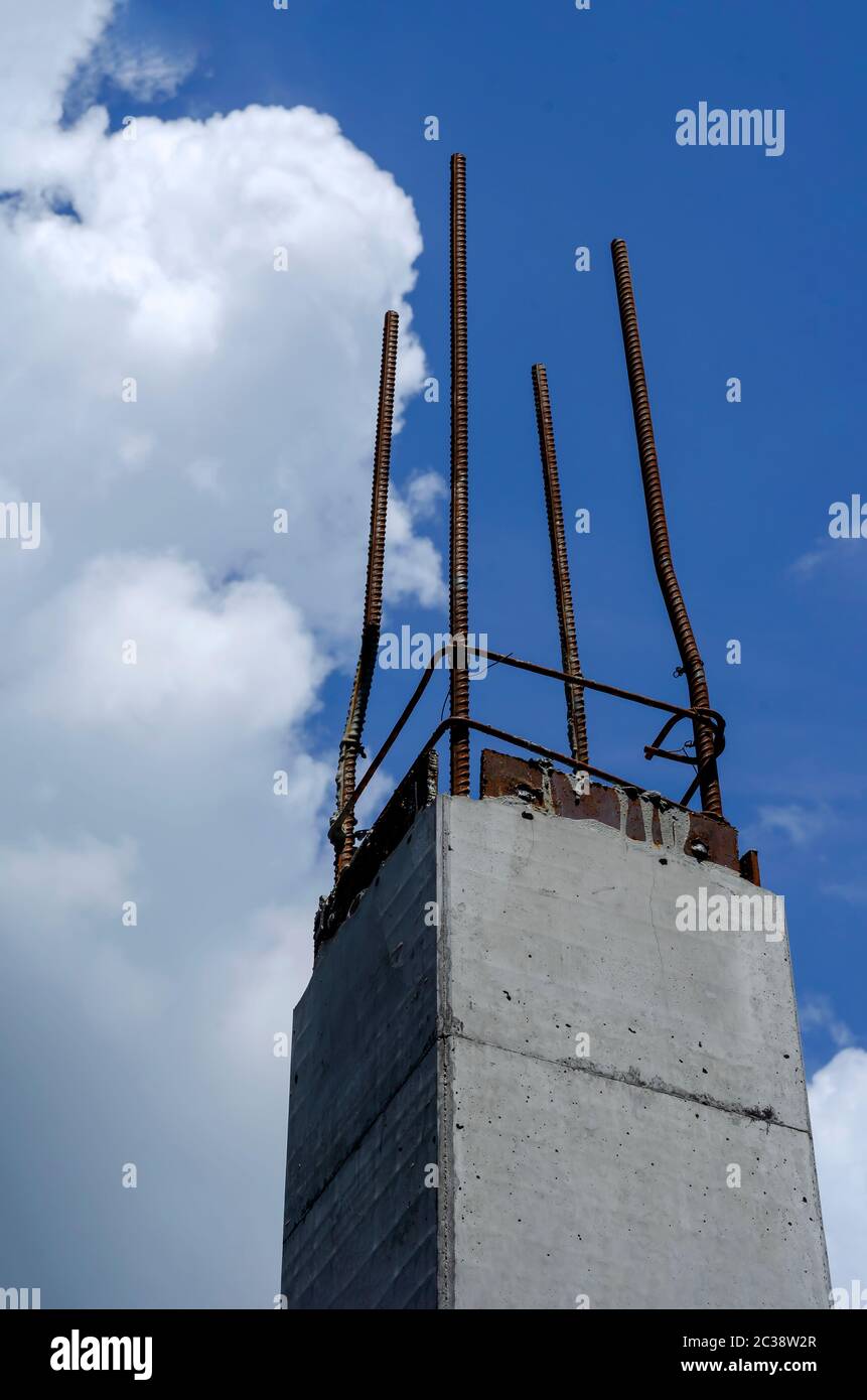 Concrete pile with reinforcement against the sky. The construction of a ...