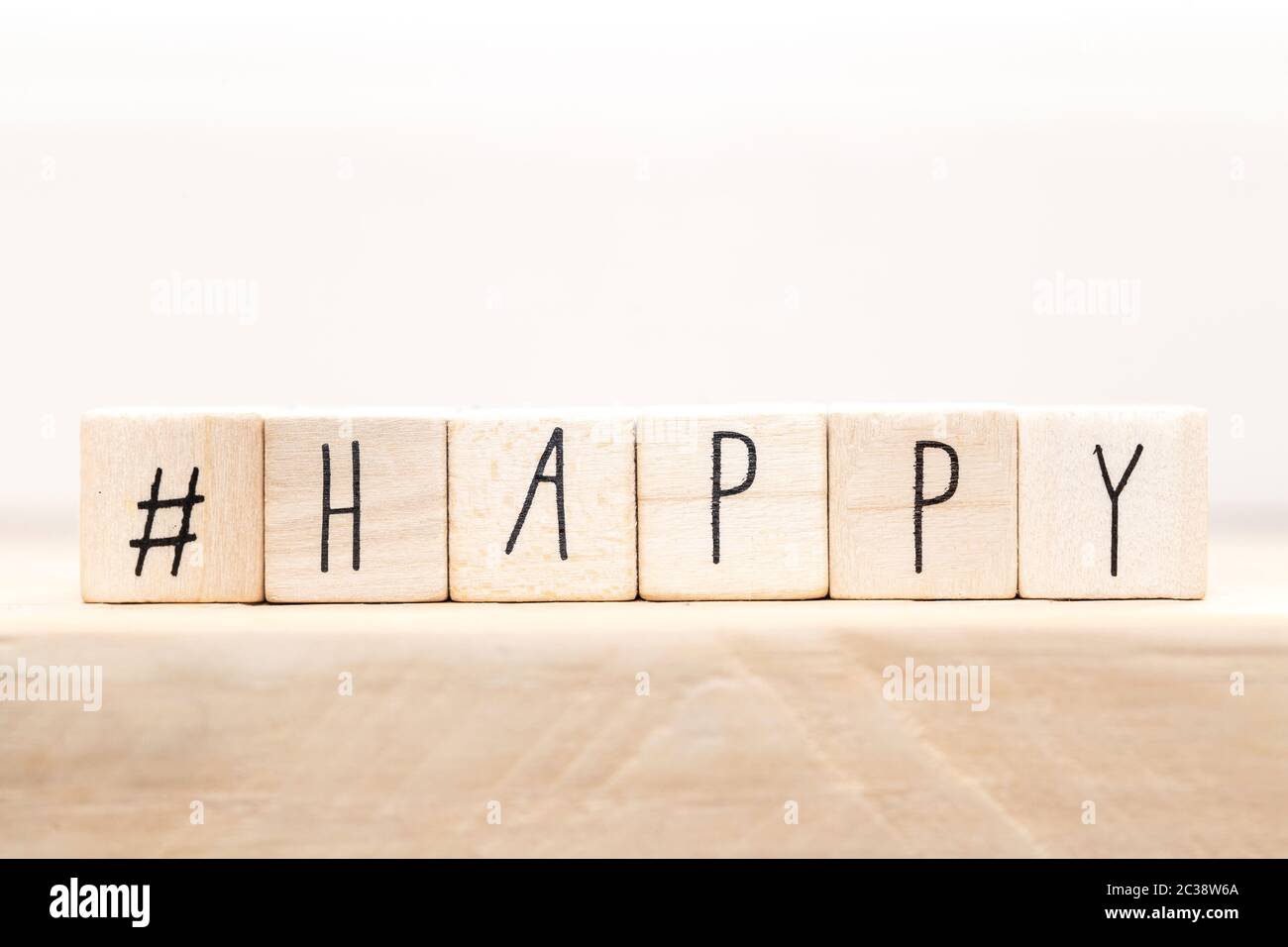 Wooden cubes with a Hashtag and the word Happy, smile and heart, social ...