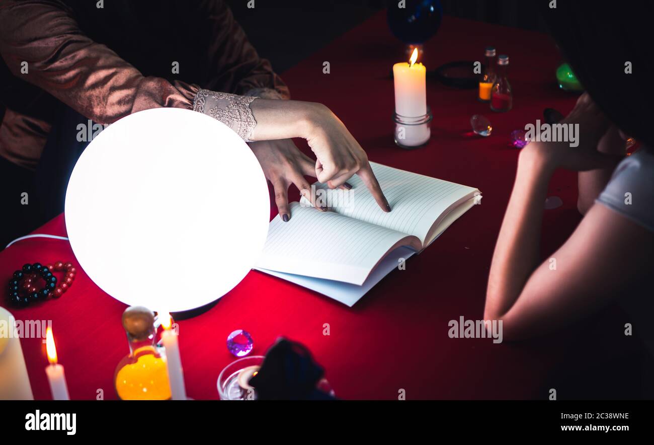 A black woman dressed as a witch performs a ritual in a mysterious ...