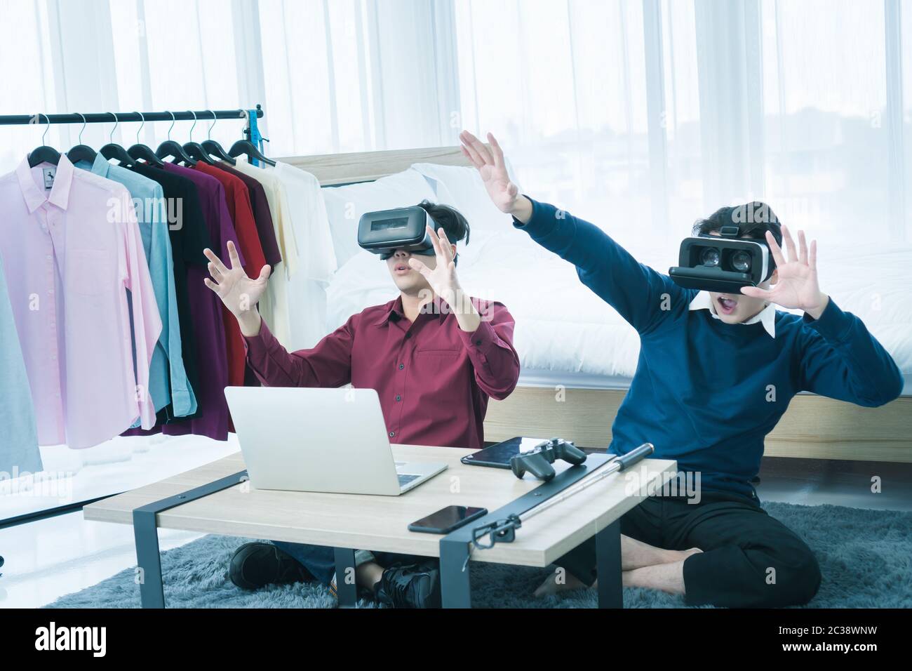 Two Asian men are having fun reviewing and selling products via live ...