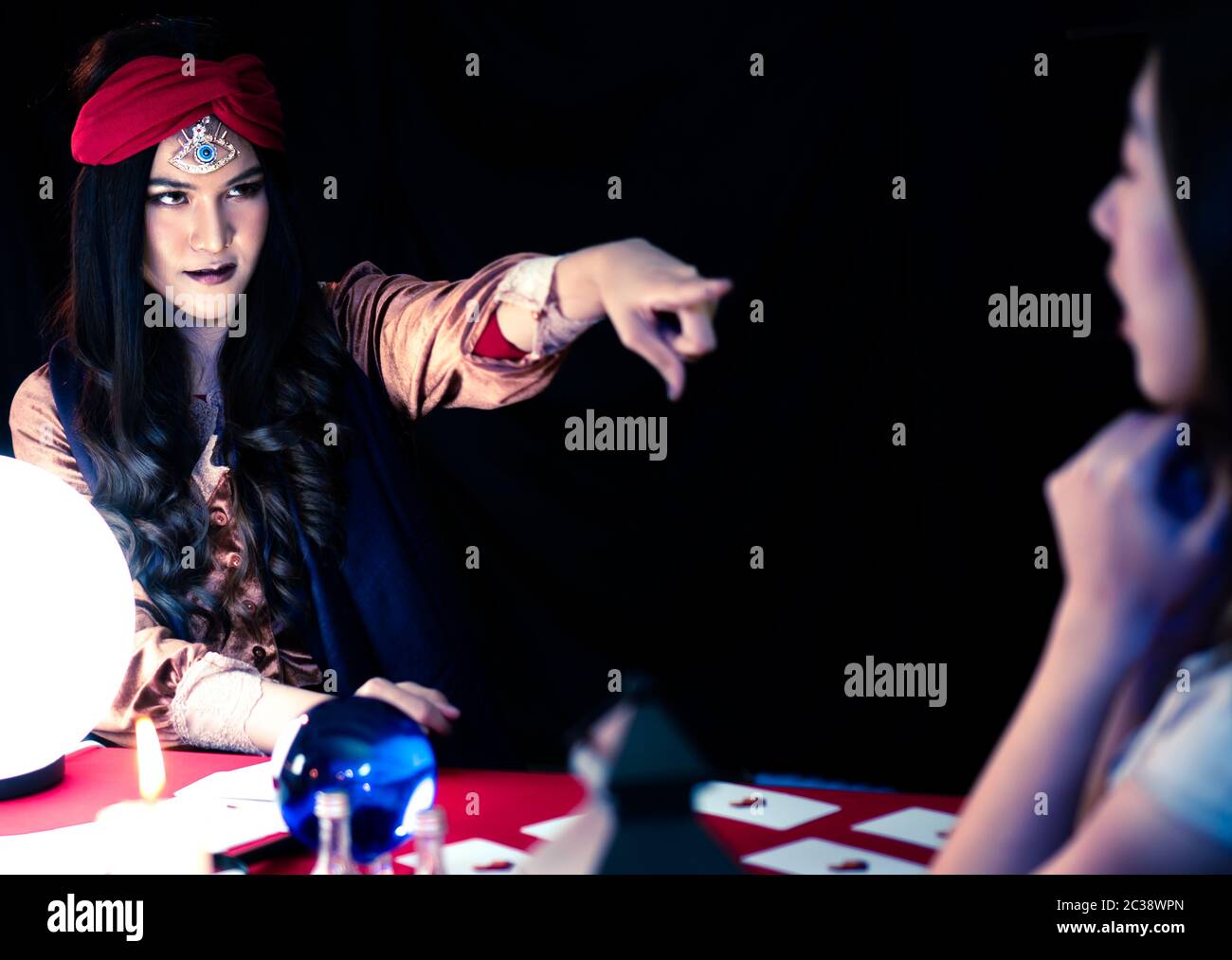 A black woman dressed as a witch performs a ritual in a mysterious ...