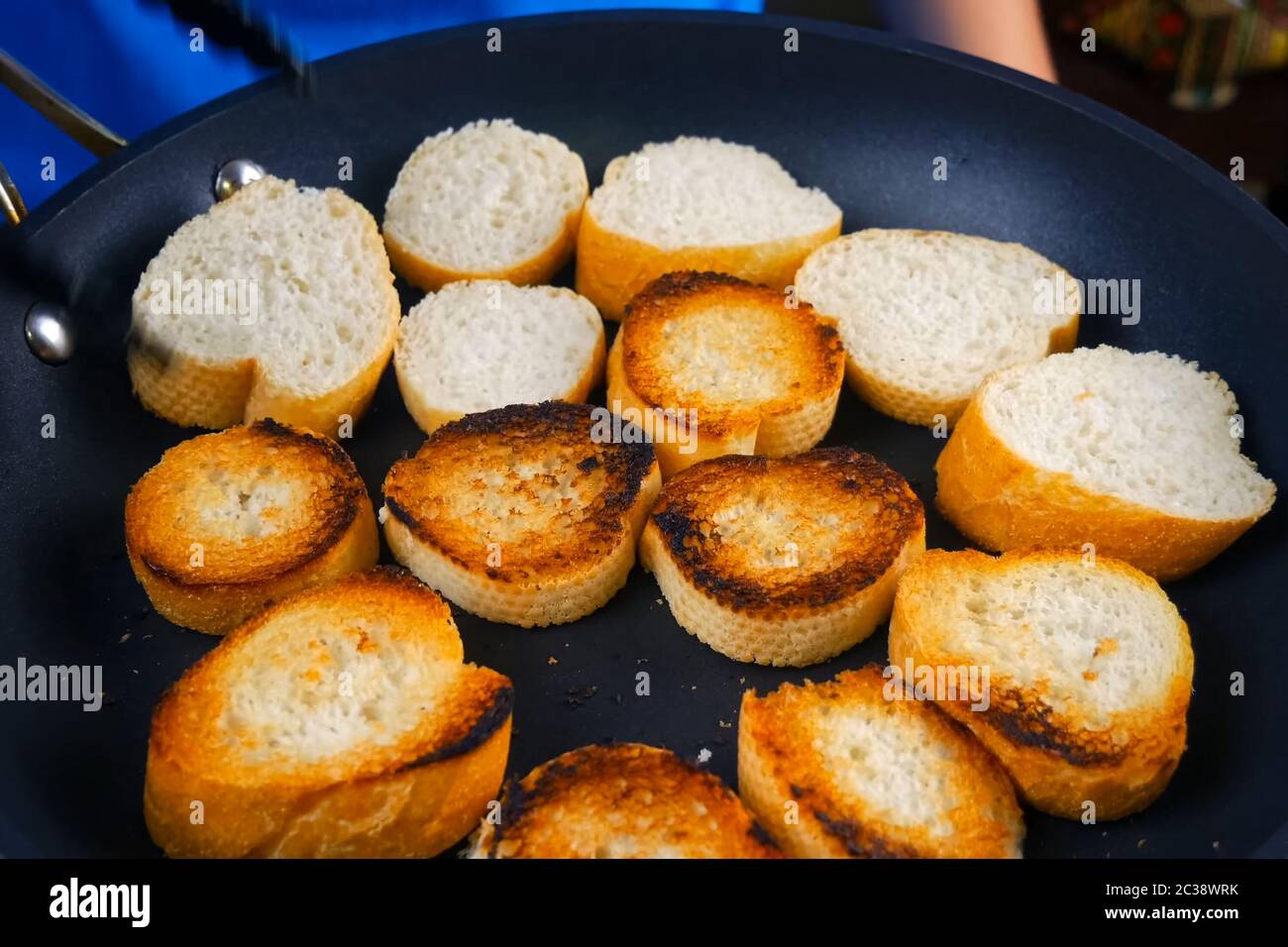 Frying slices of bread in a pan. Toasting bread for a sandwich Stock ...