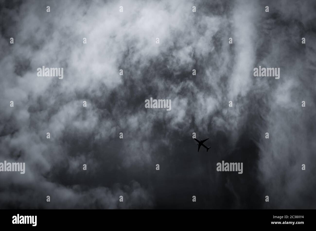 Airplane flying on dark sky and white clouds. Commercial airline with ...
