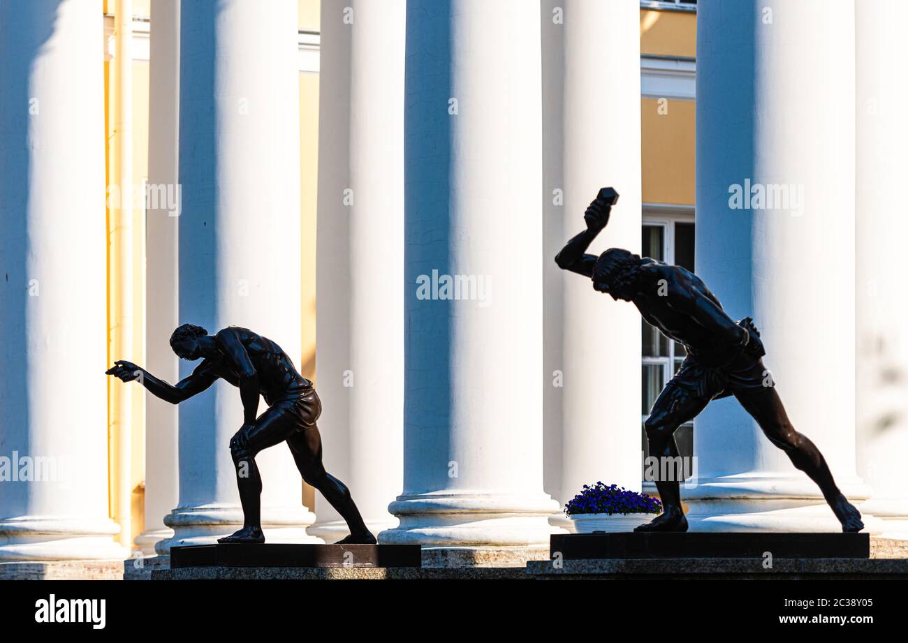 Two statues depicting ancient people with columns in background, Russia ...