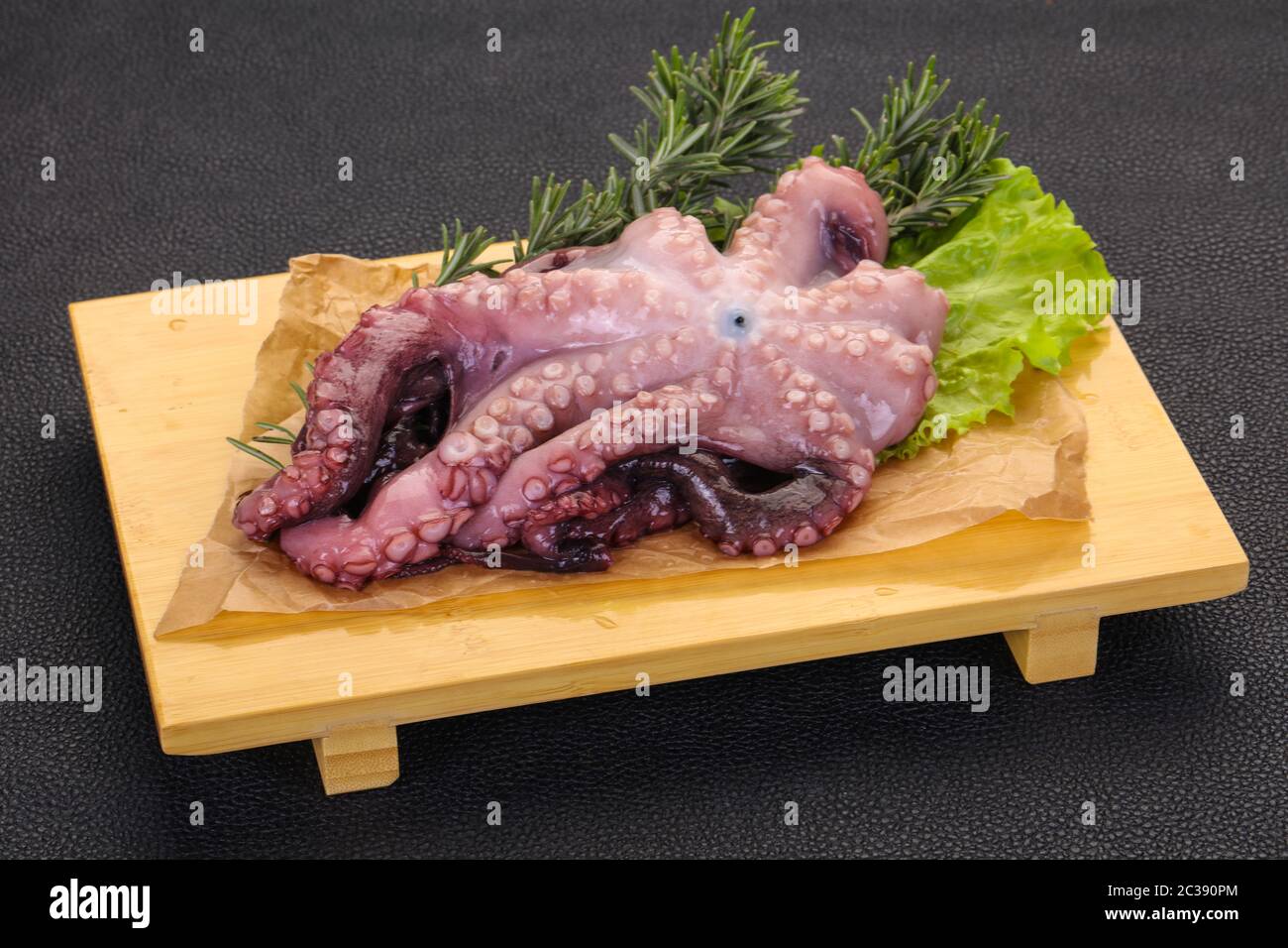Raw octopus ready for cooking with rosemary Stock Photo - Alamy