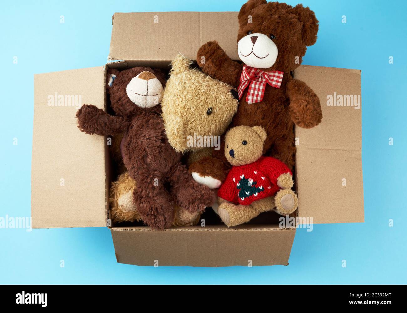 brown cardboard box with various teddy bears, top view, concept of ...