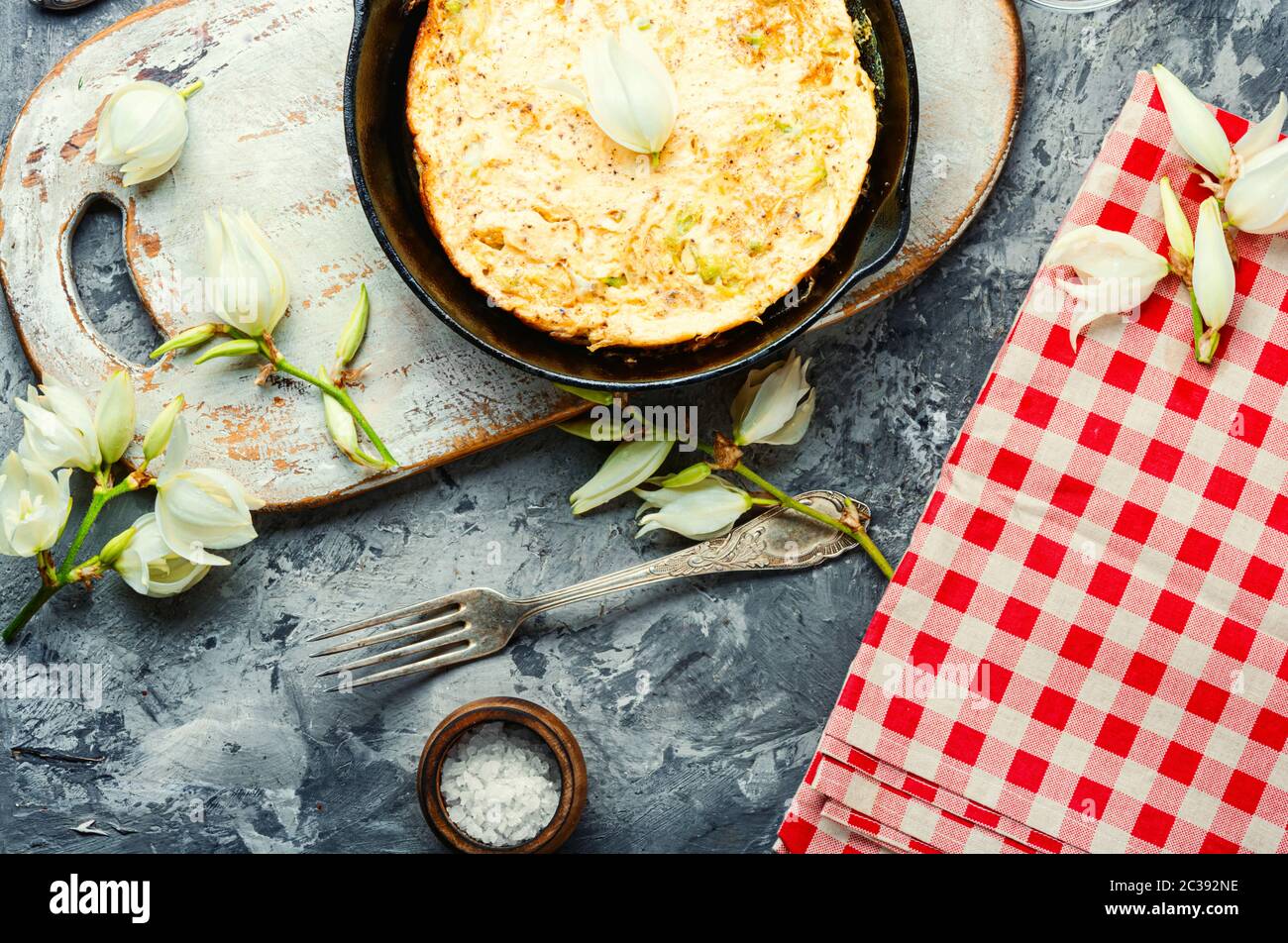 Frying pan with scrambled eggs stuffed with edible yucca flowers ...