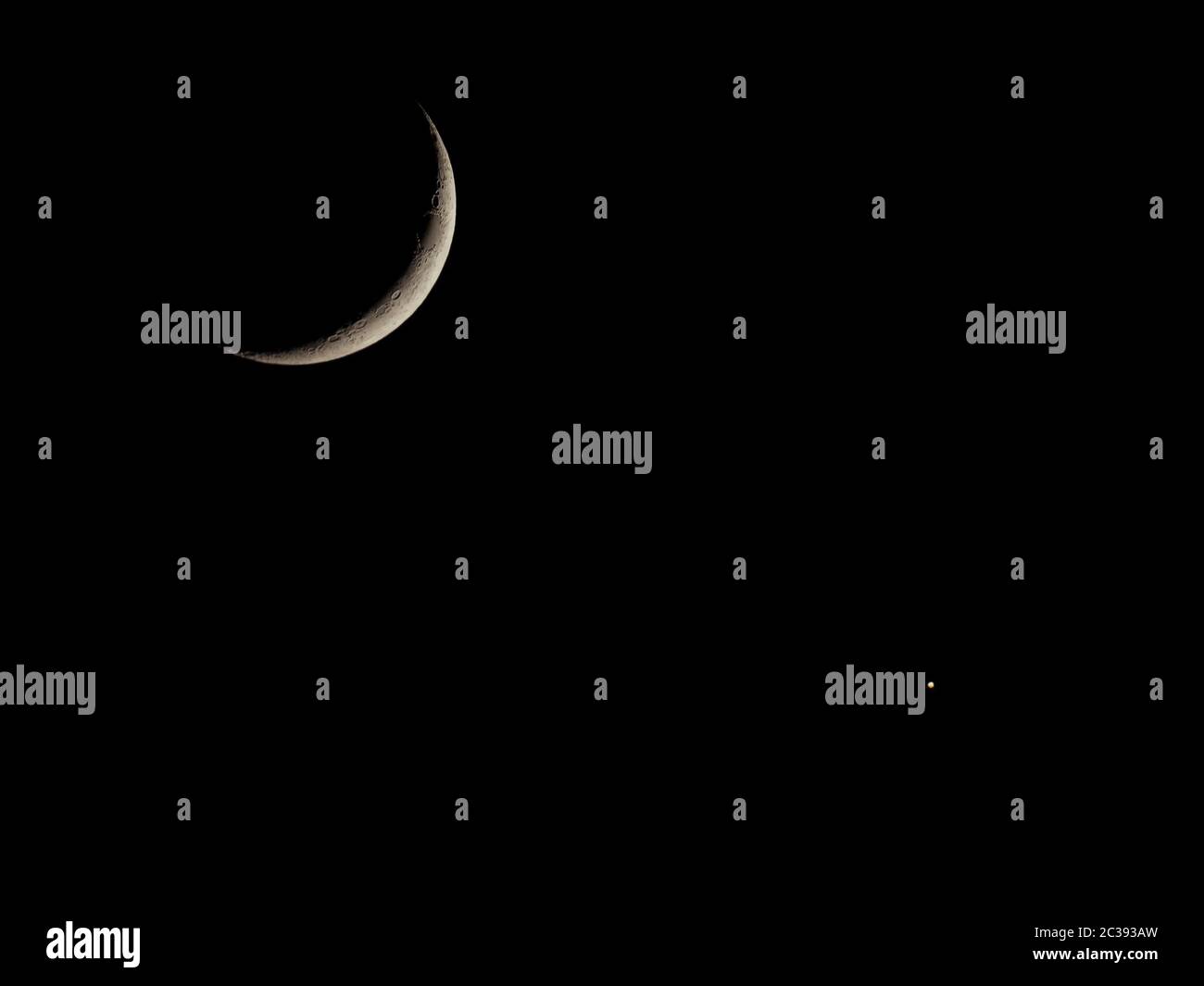 Waxing crescent moon and planet venus seen with an astronomical ...