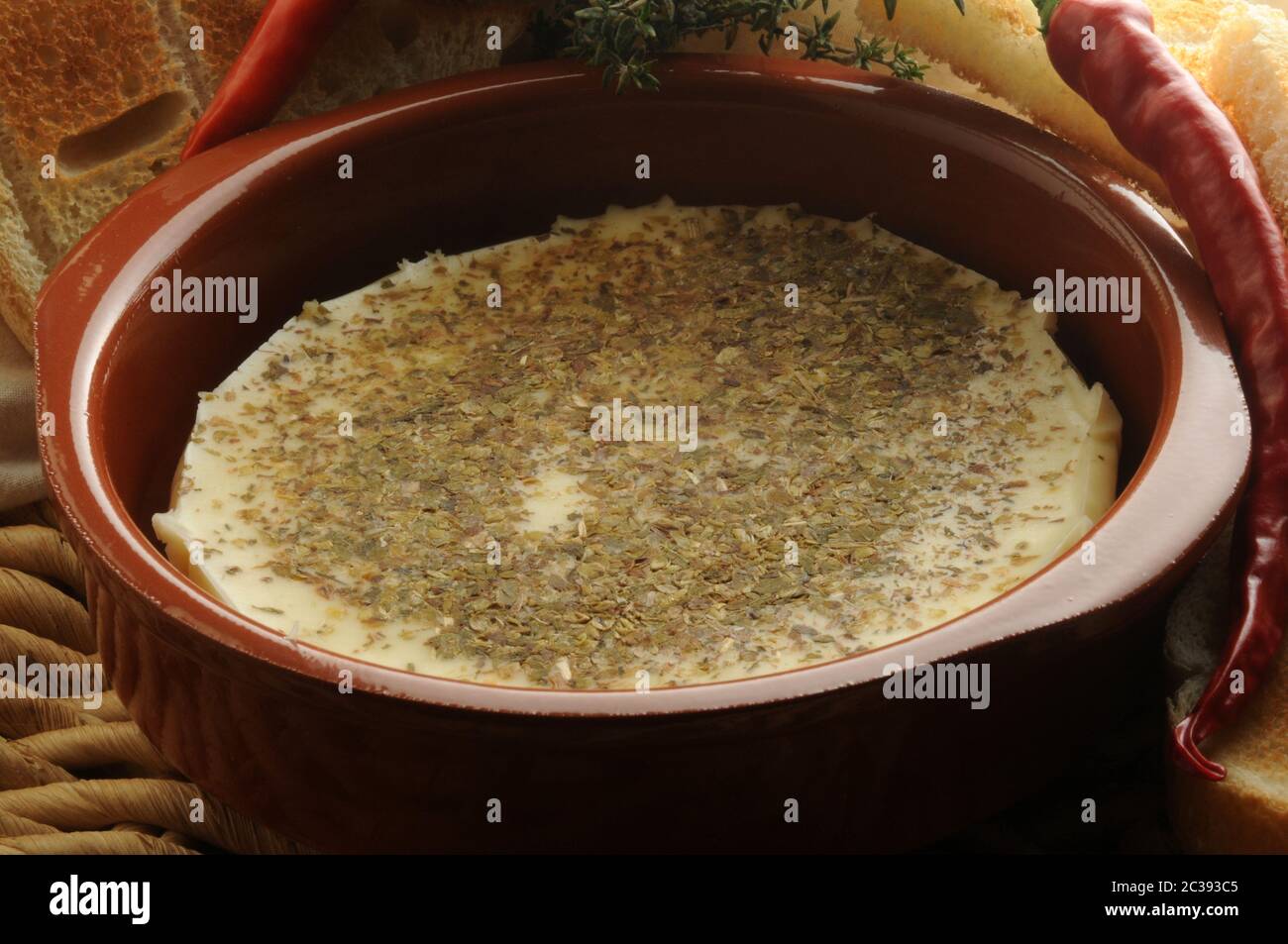 Provolone cheese melted with oregano and chilli pepper Stock Photo - Alamy