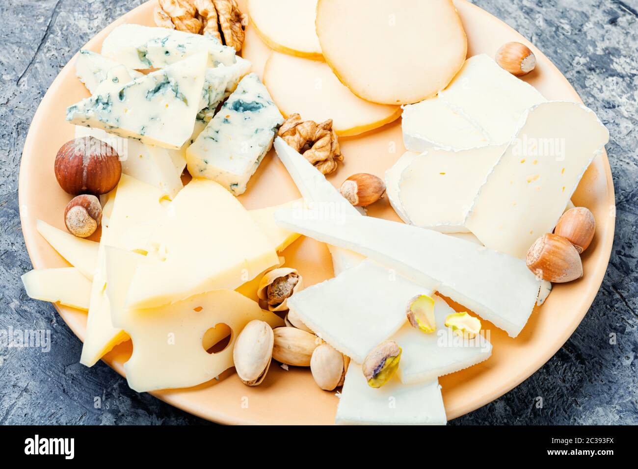 Assortment of different cheese types on plate.Piece of cheese Stock Photo - Alamy