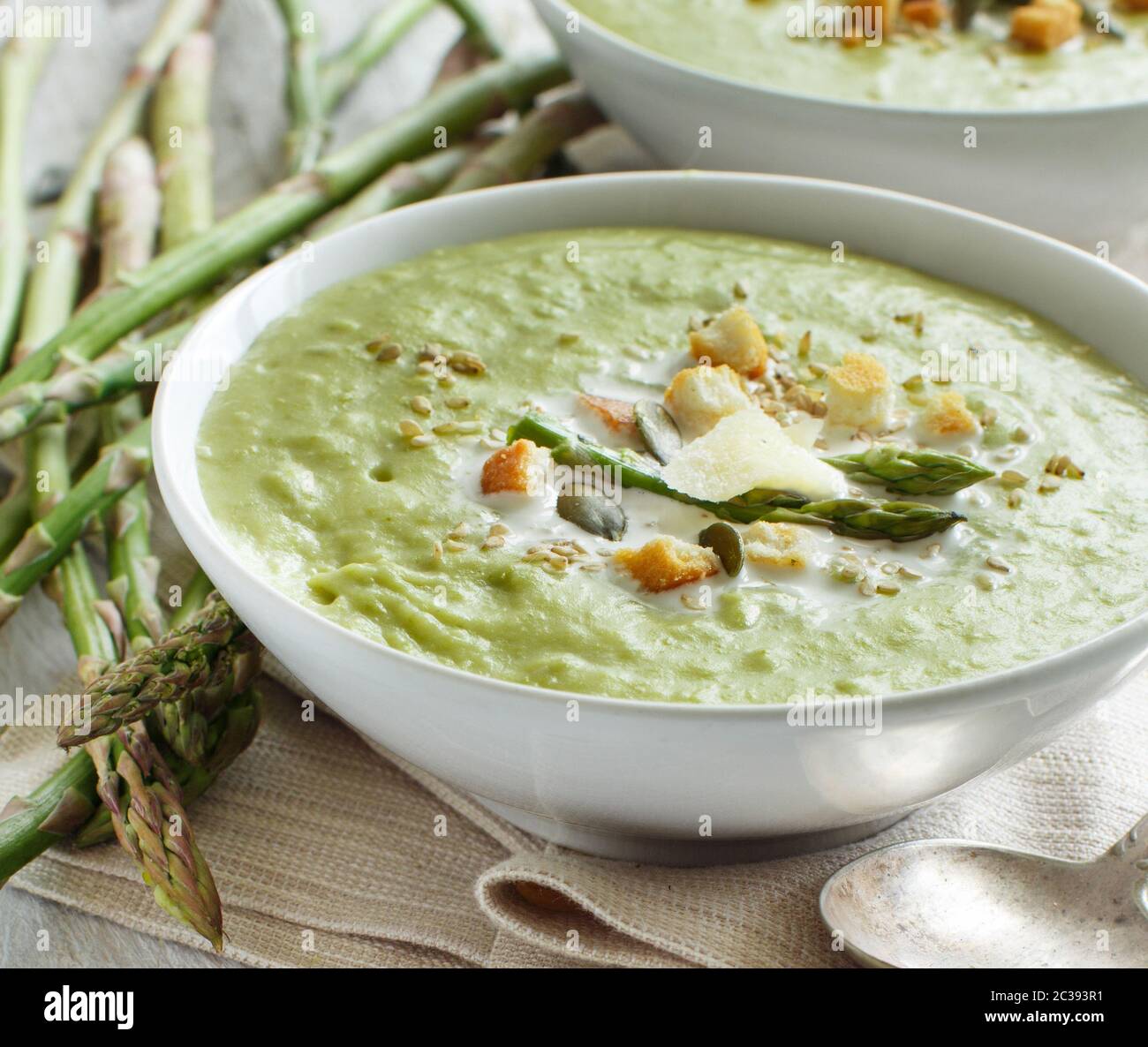 Creamy asparagus and potatoes soup puree on a wooden table Stock Photo ...
