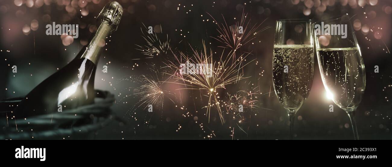 Champagne in front of colorful fireworks on night sky. Background for ...