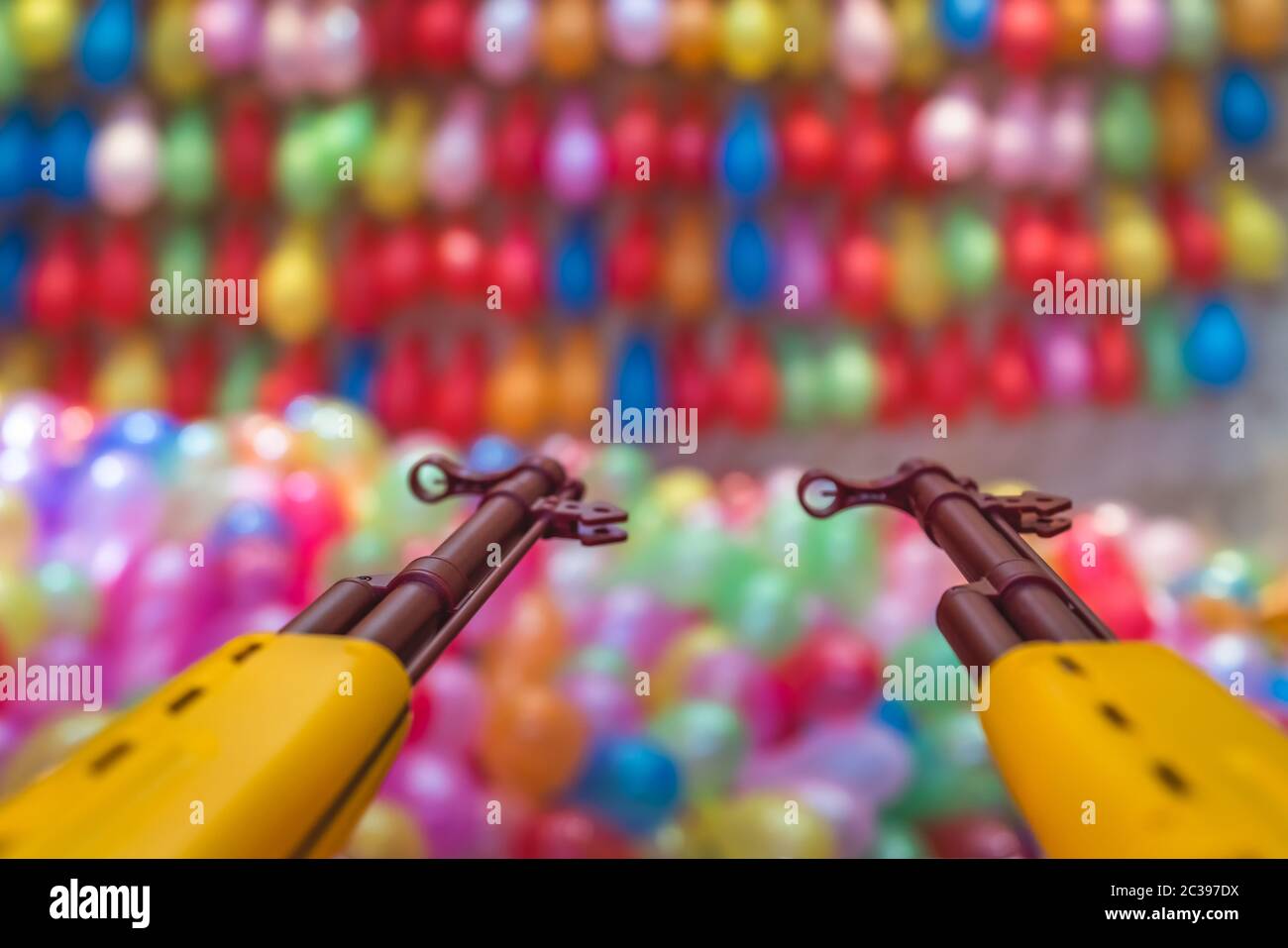 Rubber bullet guns pointed at balloons Stock Photo - Alamy