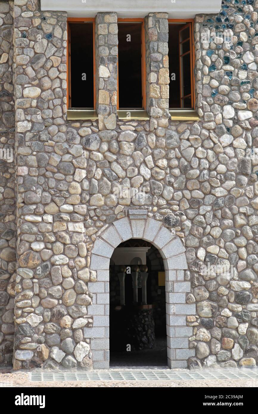 Old stone house exterior with arch door Stock Photo - Alamy