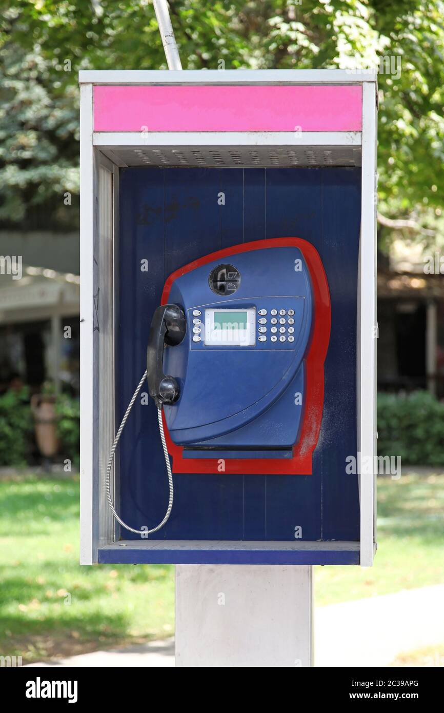 Modern blue payphone booth with card slot Stock Photo - Alamy