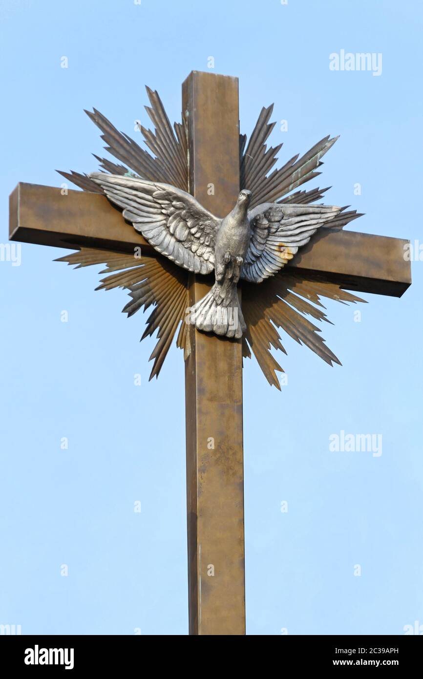 Silver dove with open wings at cross peace symbol Stock Photo - Alamy