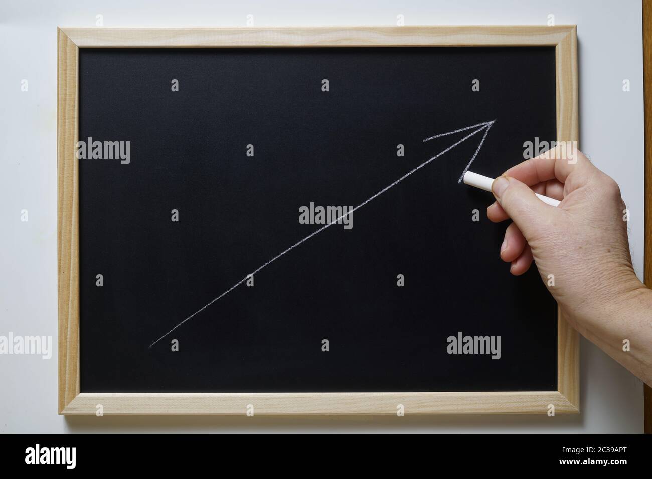 a blackboard with an arrow indicating the rise Stock Photo - Alamy