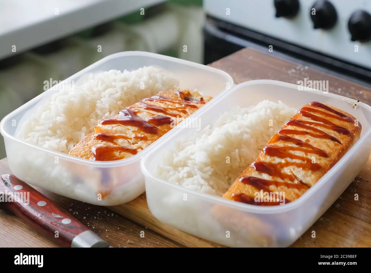 Rice porridge and fried fish in a plastic container Stock Photo - Alamy