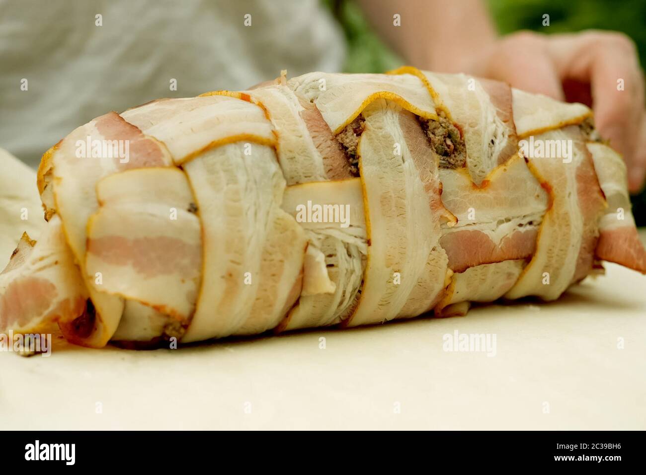 Folding raw meatloaf, cooking meatloaf. Folding raw Stock Photo - Alamy