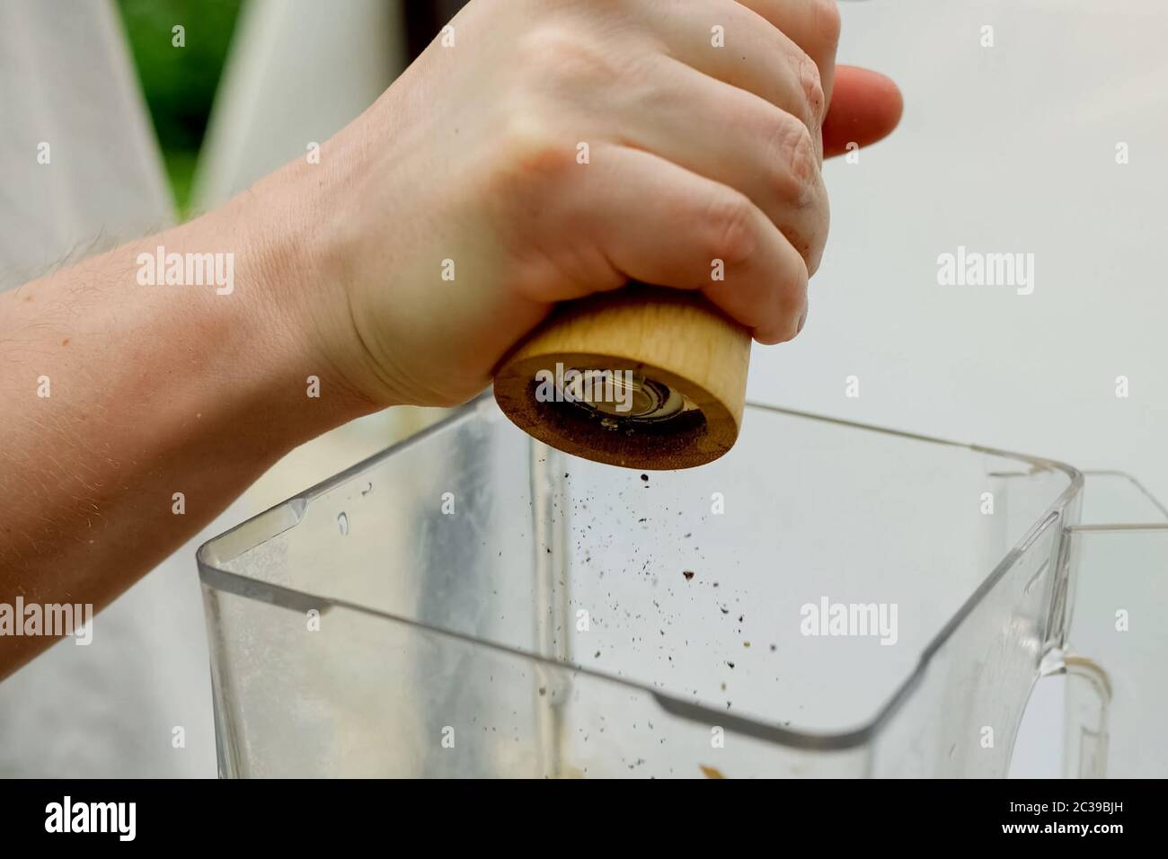 Grinding spices and shaking them in a dish. Spices in food Stock Photo ...