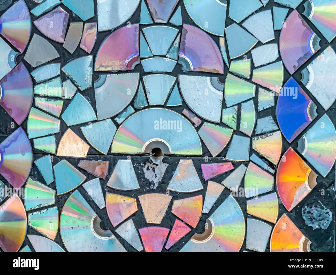 Chips of cd discs laid out on a black background. Background image ...