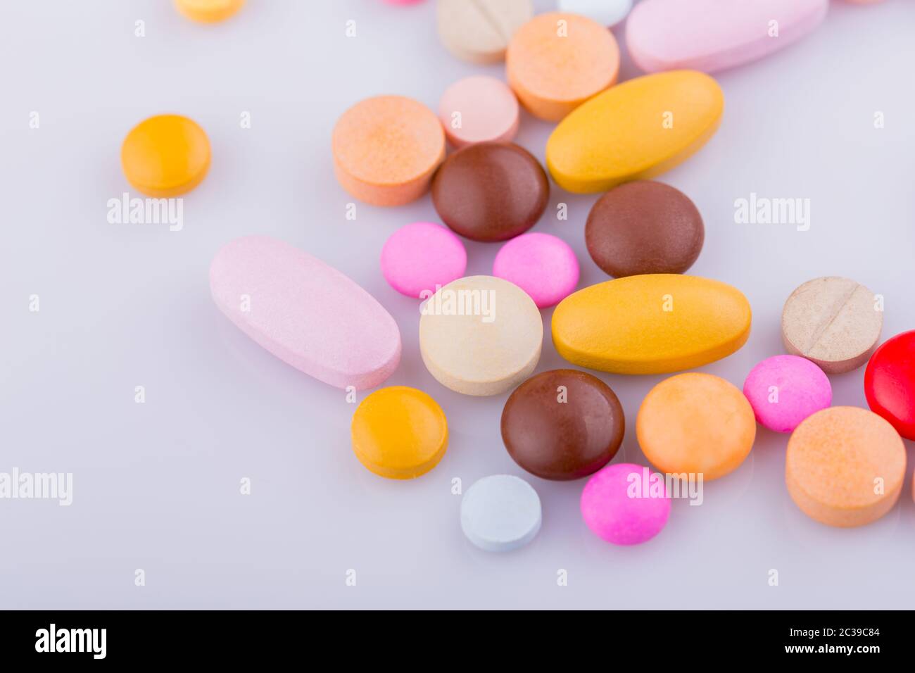 Tablets pills capsule heap mix therapy drugs, over a white background ...