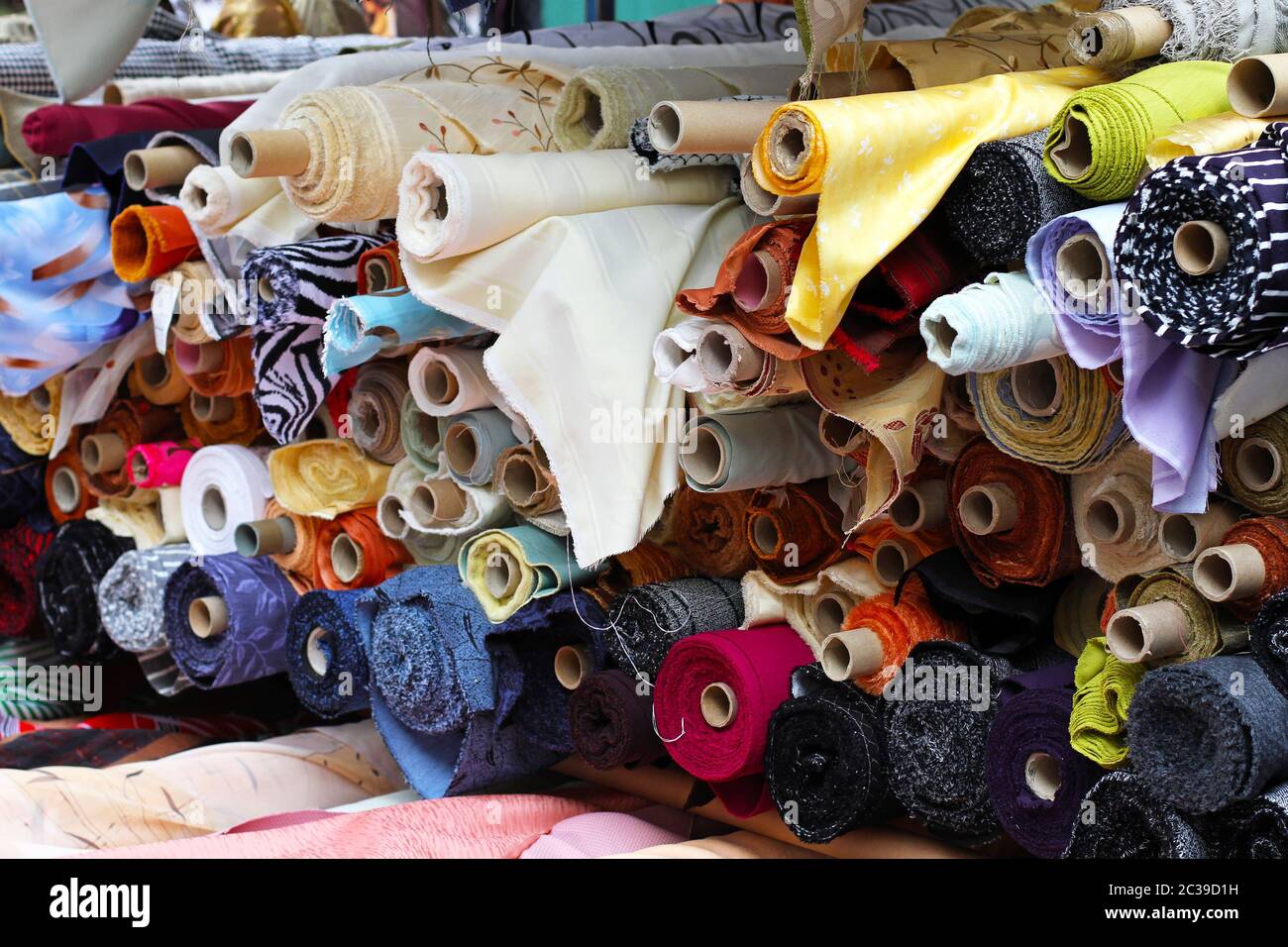 Fabric rolls in shelf for fashion industry Stock Photo - Alamy