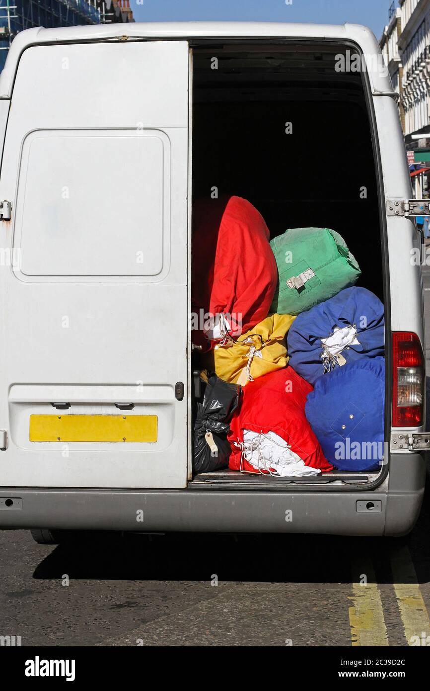 Laundry cleaning service delivery van with bags Stock Photo - Alamy