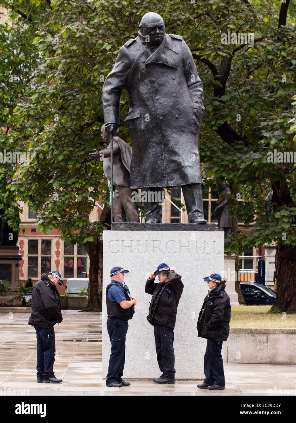 Police officers stand guard at The Statue of Winston Churchill which ...