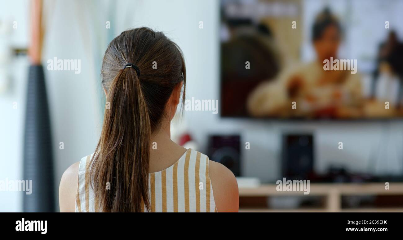 Woman watch tv at home Stock Photo - Alamy