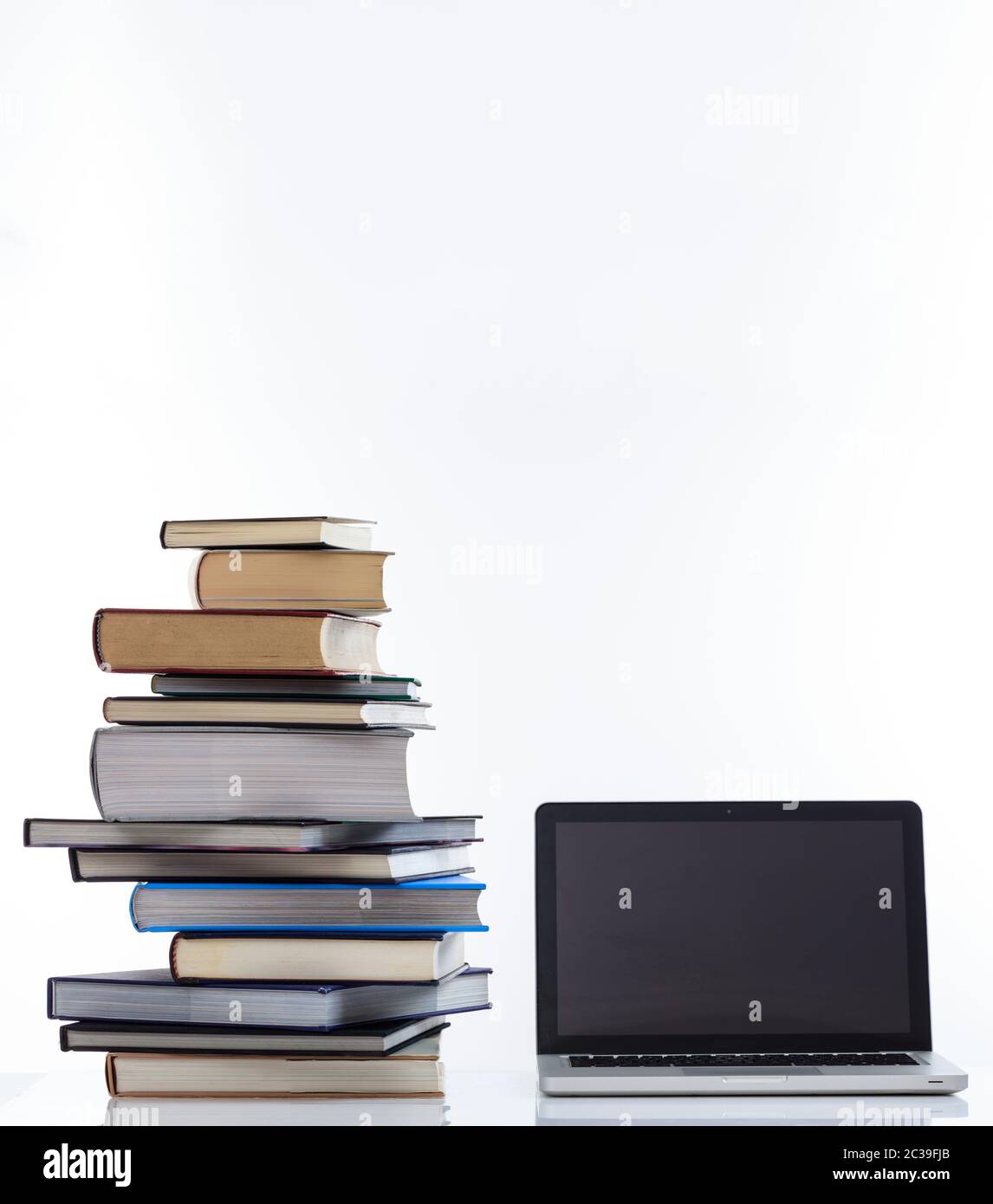 E learning concept. Books stack and an open computer laptop with black ...