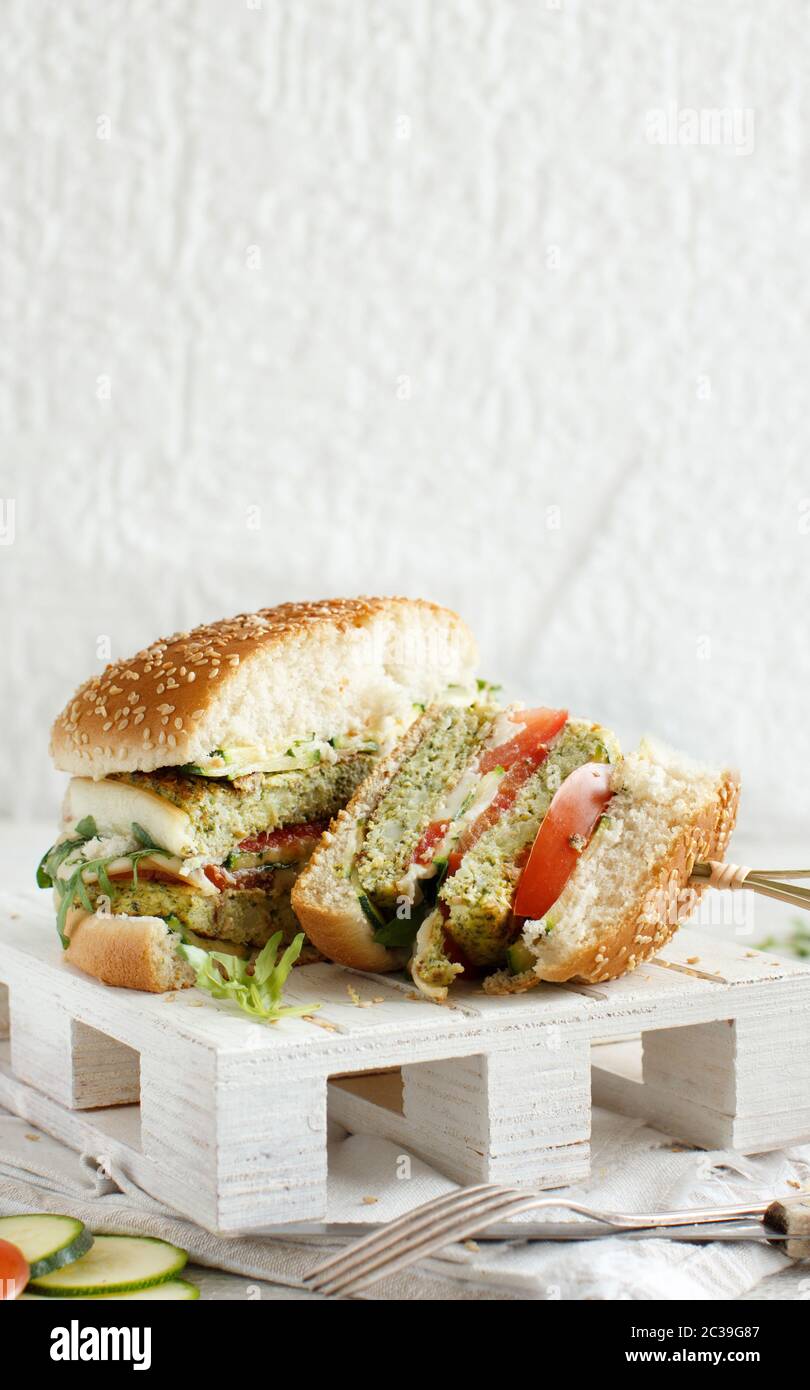 Healthy vegetarian burger with broccoli burger, arugula, zucchini and ...