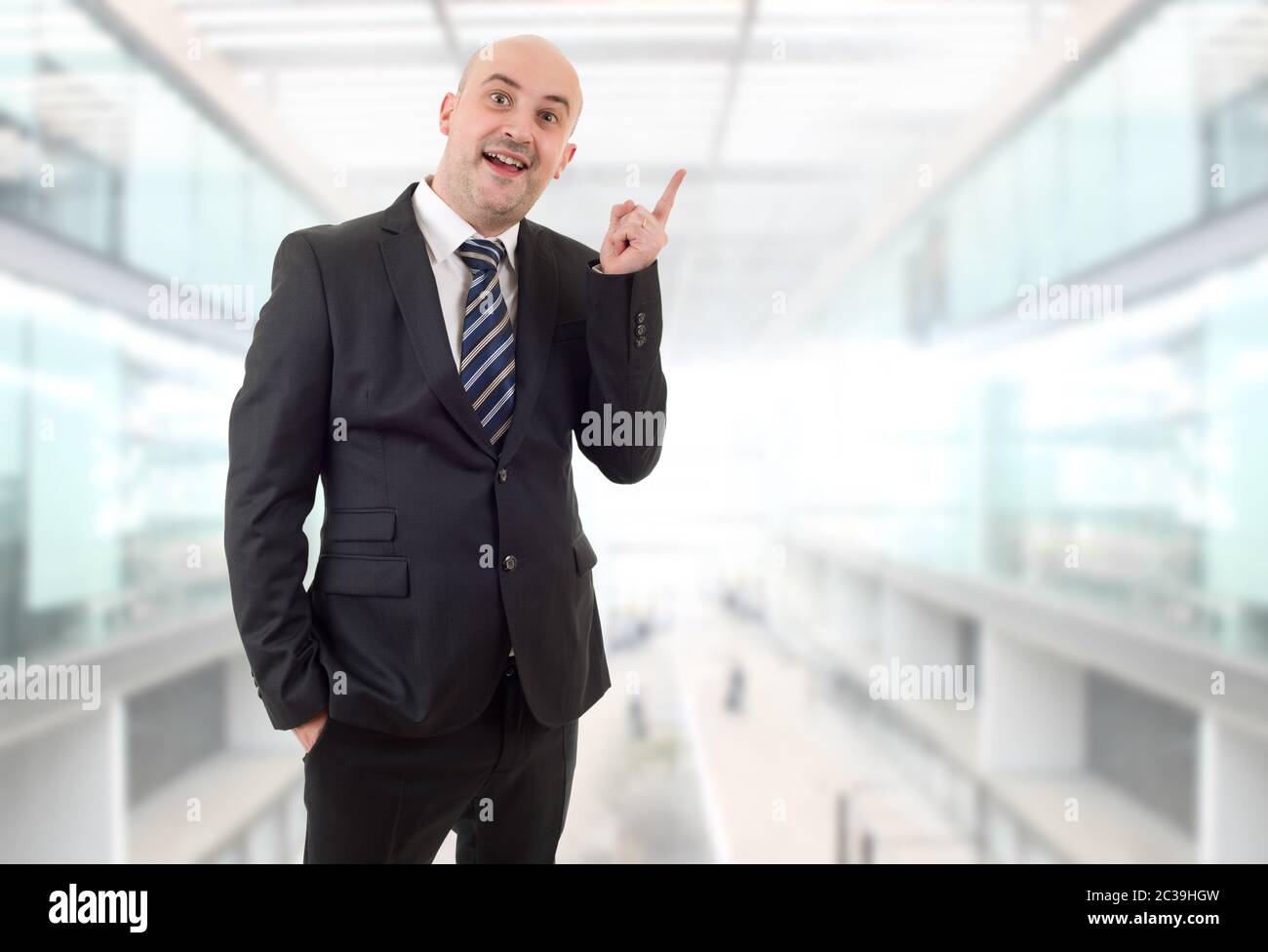 happy business man pointing, at the office Stock Photo - Alamy