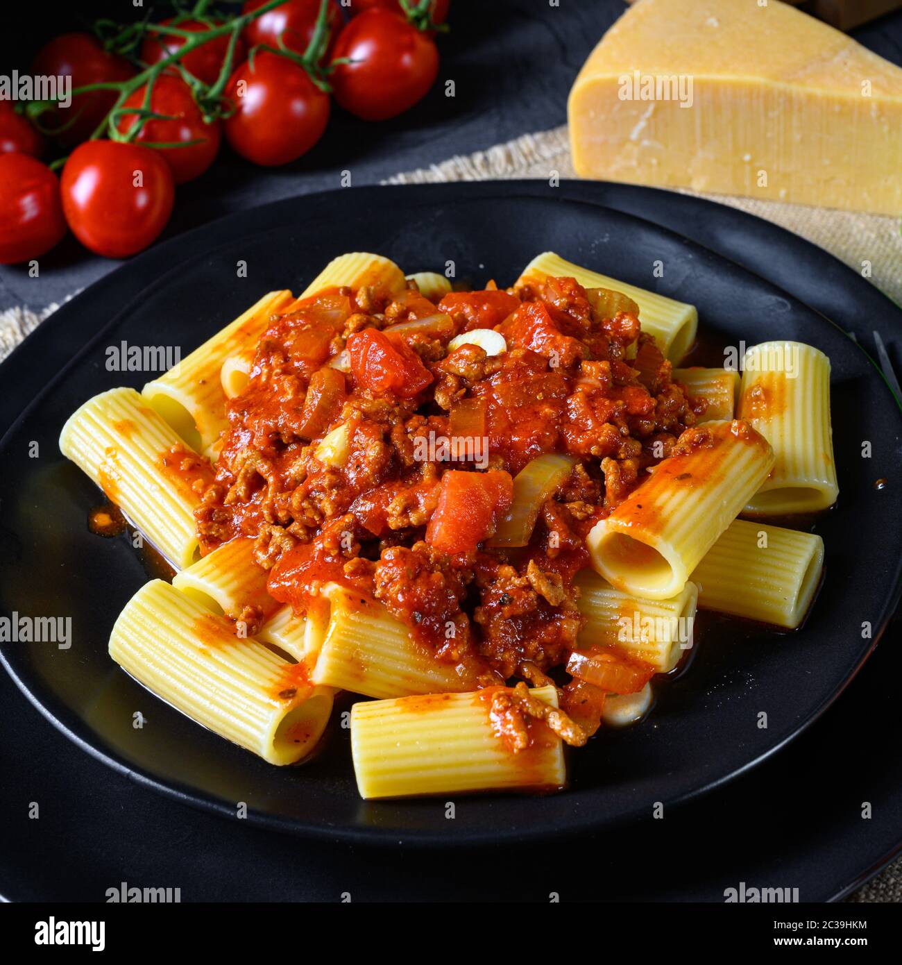 Rigatoni pasta with Bolognese sauce and fresh basil Stock Photo - Alamy
