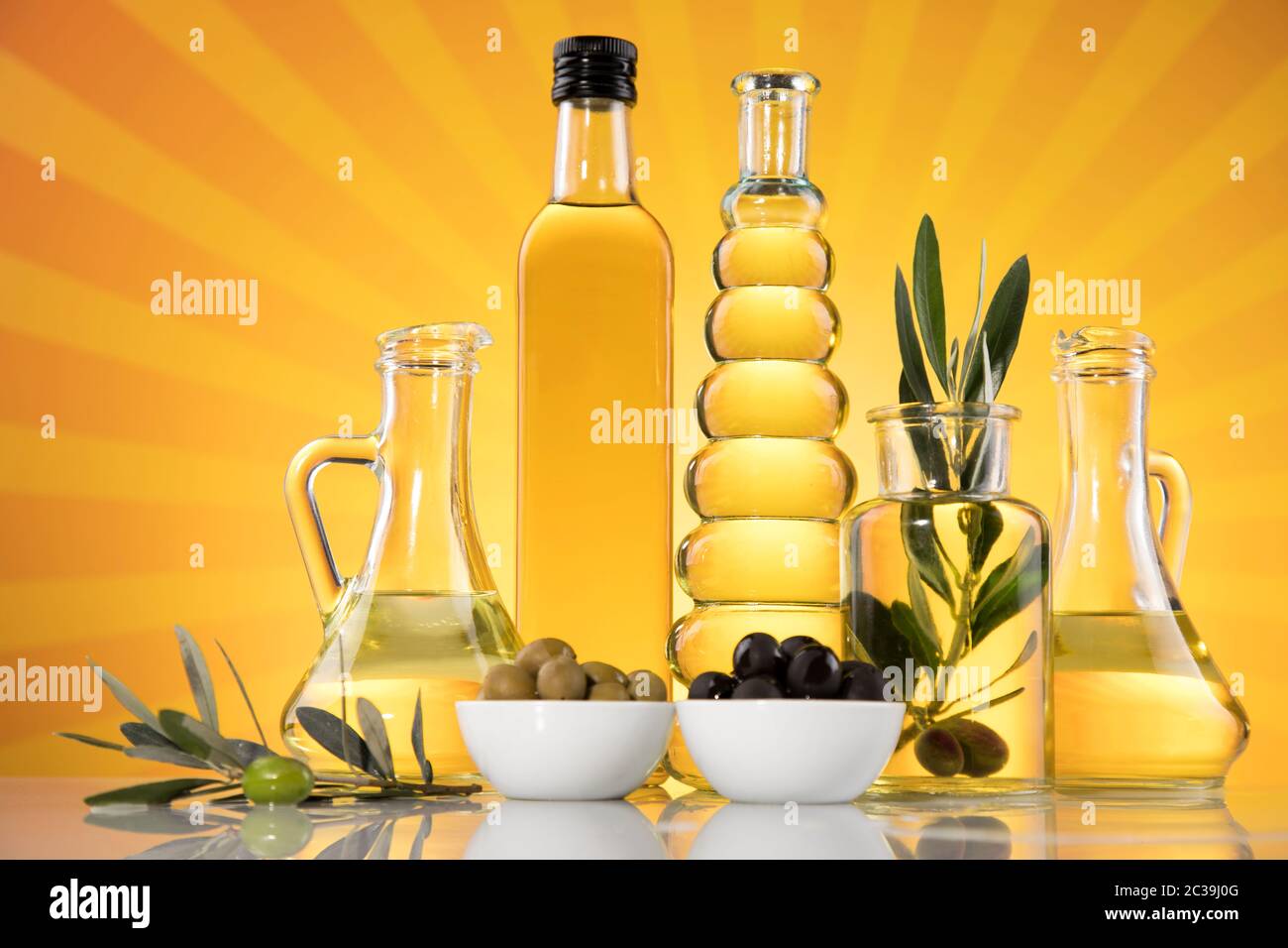 Bottles with organic cooking olive oil and olive branch Stock Photo - Alamy