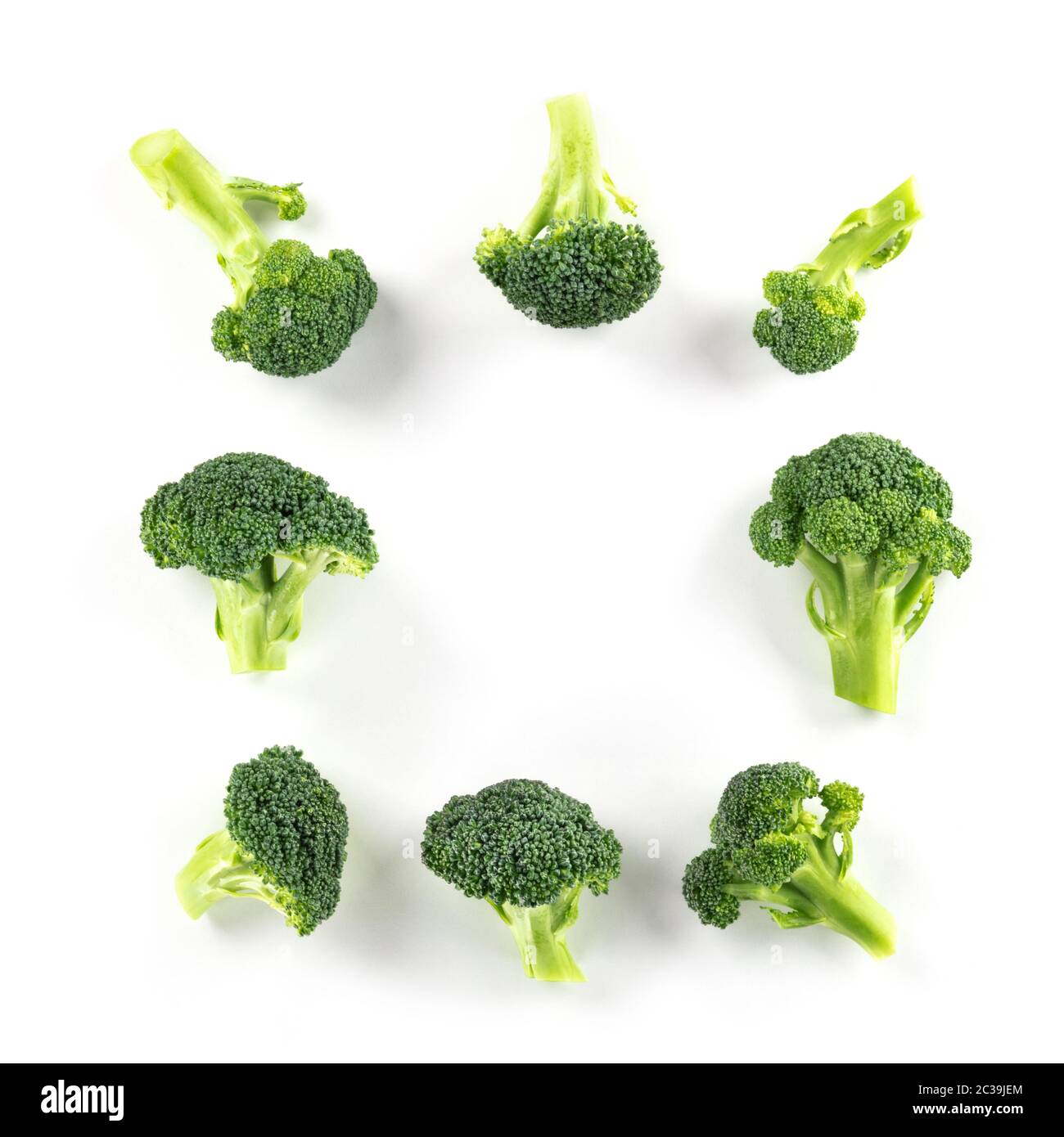 Broccoli florets, shot from above on a white background, forming a ...