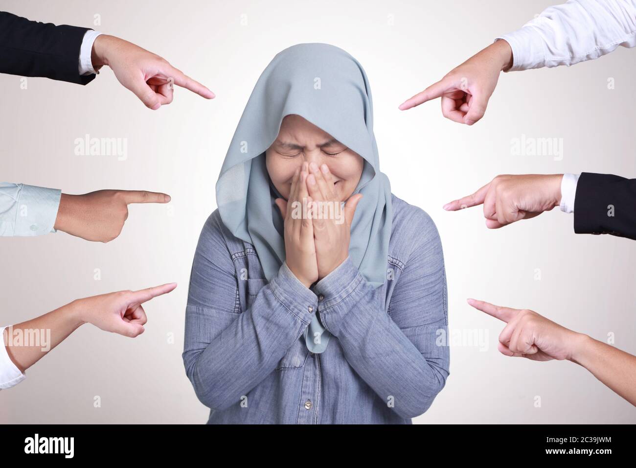 Sad anxious Asian muslim woman judged by different hands. Concept of ...