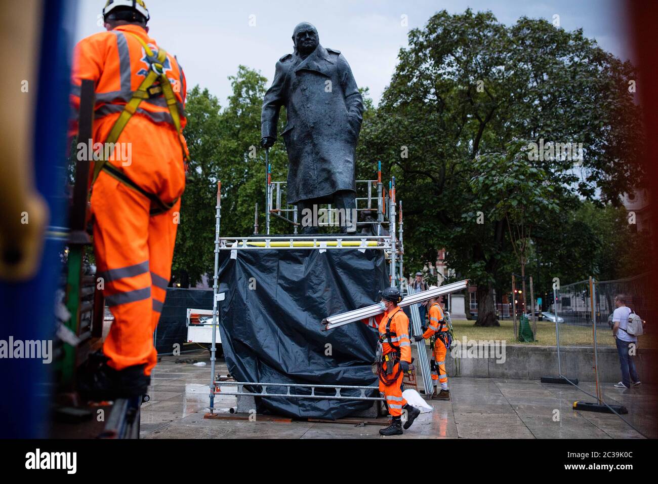 Workmen remove the protective box from around the statue of Winston ...